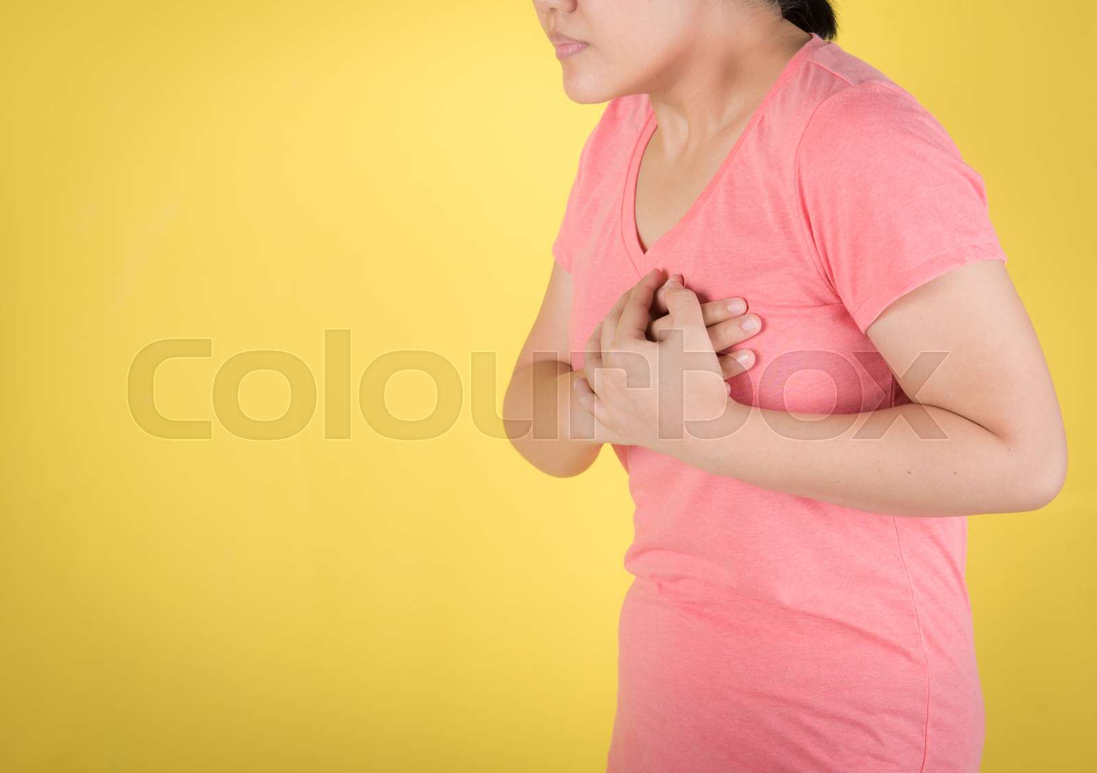 Heart attack concept,woman touch her chest | Stock image | Colourbox