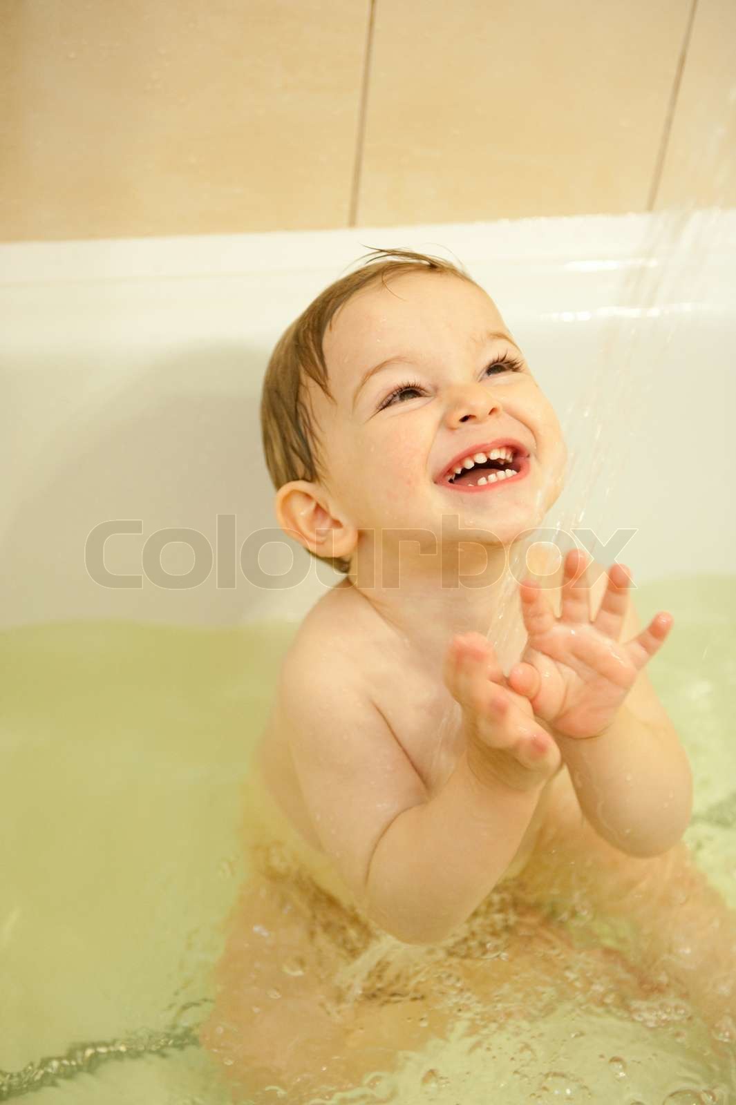 Little boy is playing with water in bath | Stock image | Colourbox