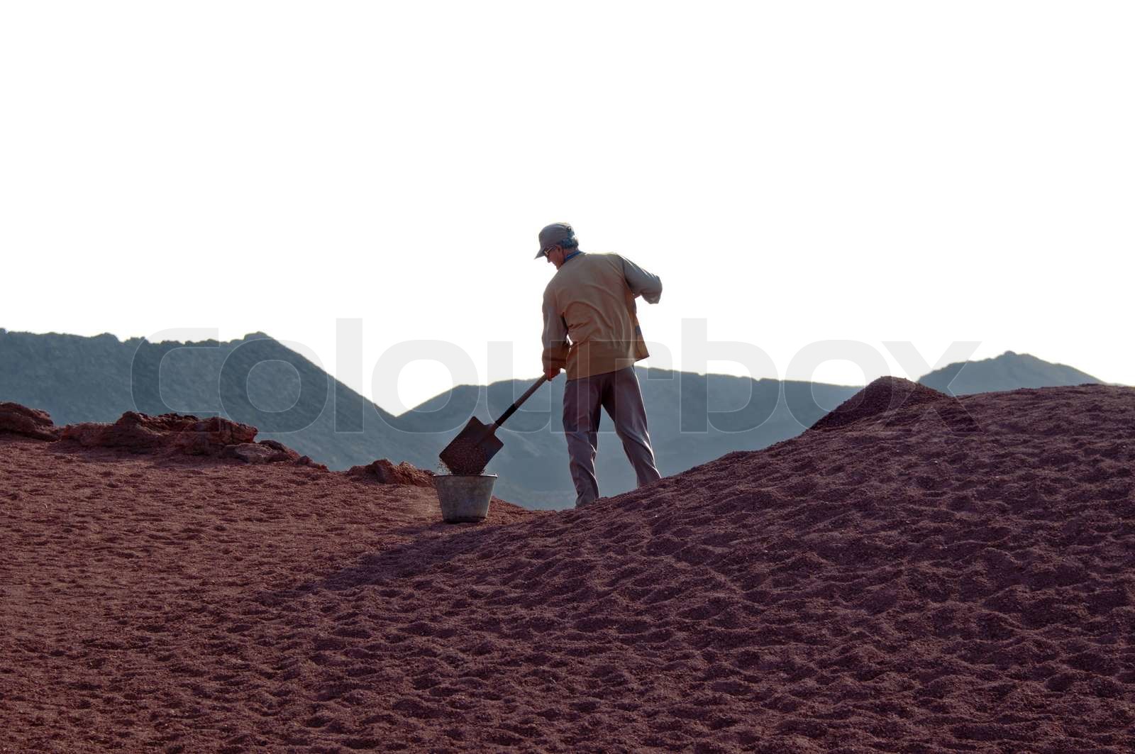 man at work shoveling dirt in the mountains | Stock image | Colourbox