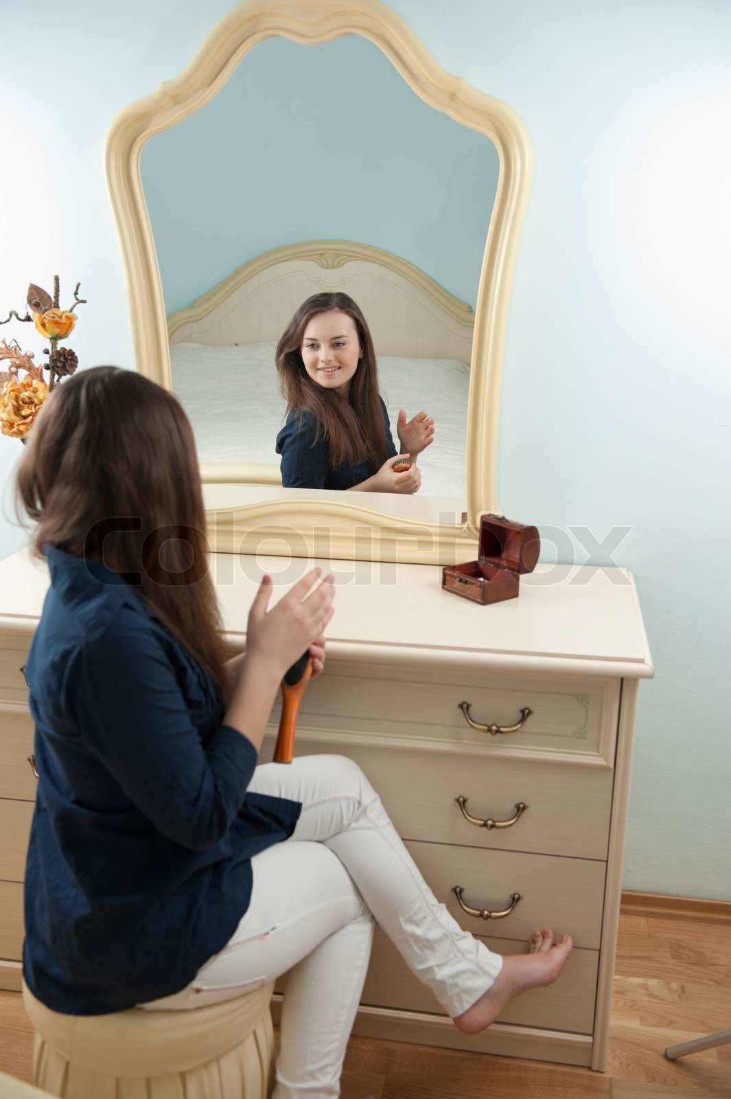 Young girl is sitting in front of mirror | Stock image | Colourbox