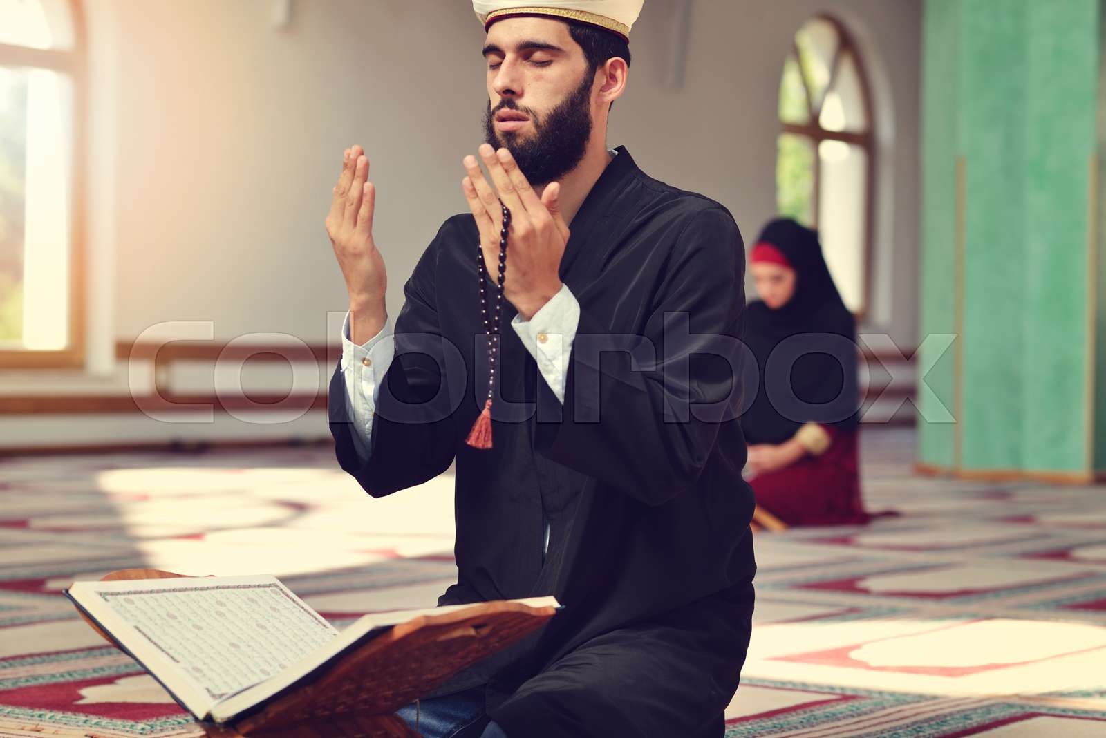 Muslim man and woman praying for Allah in the mosque together | Stock ...