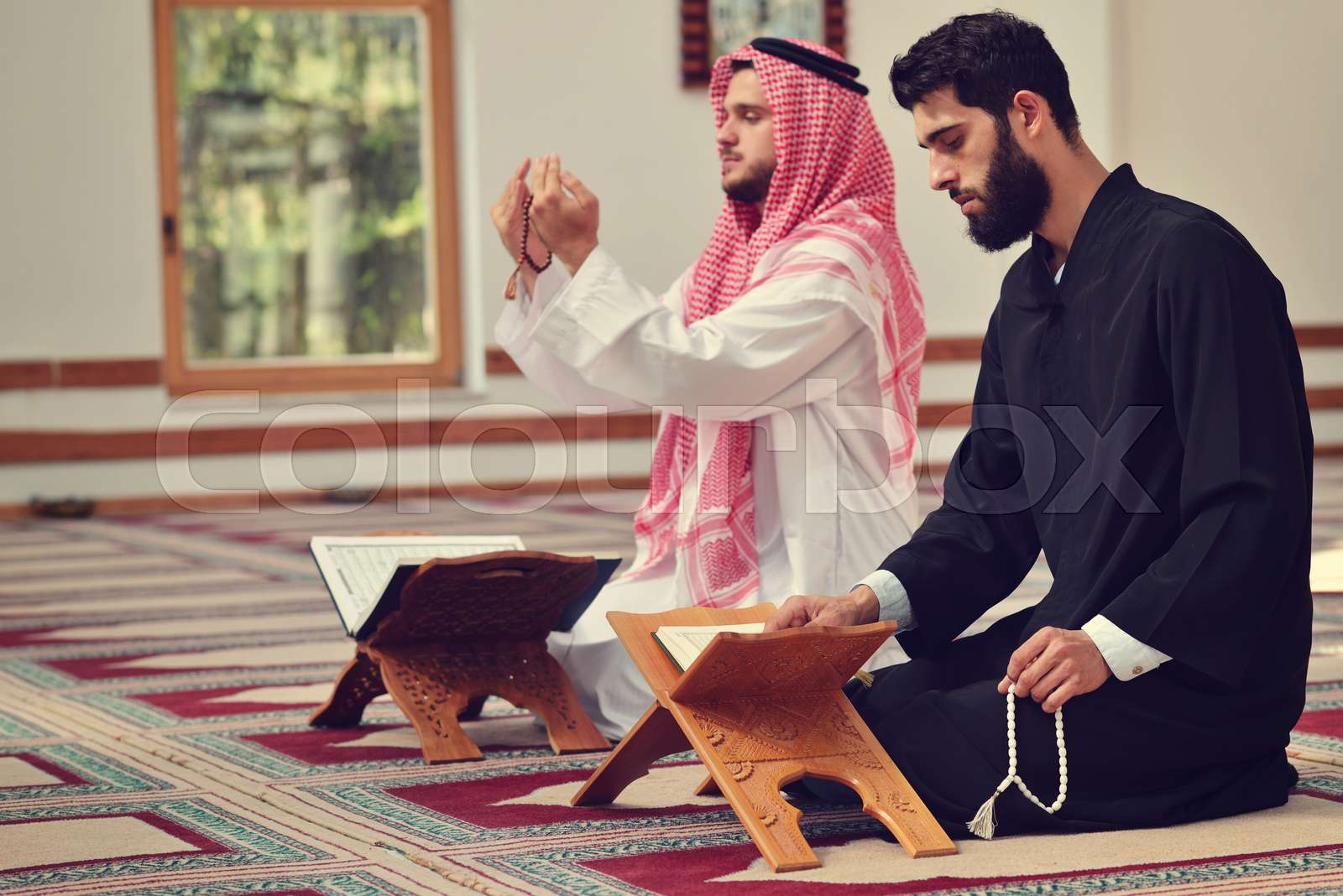 Two religious muslim man praying together inside the mosque | Stock ...
