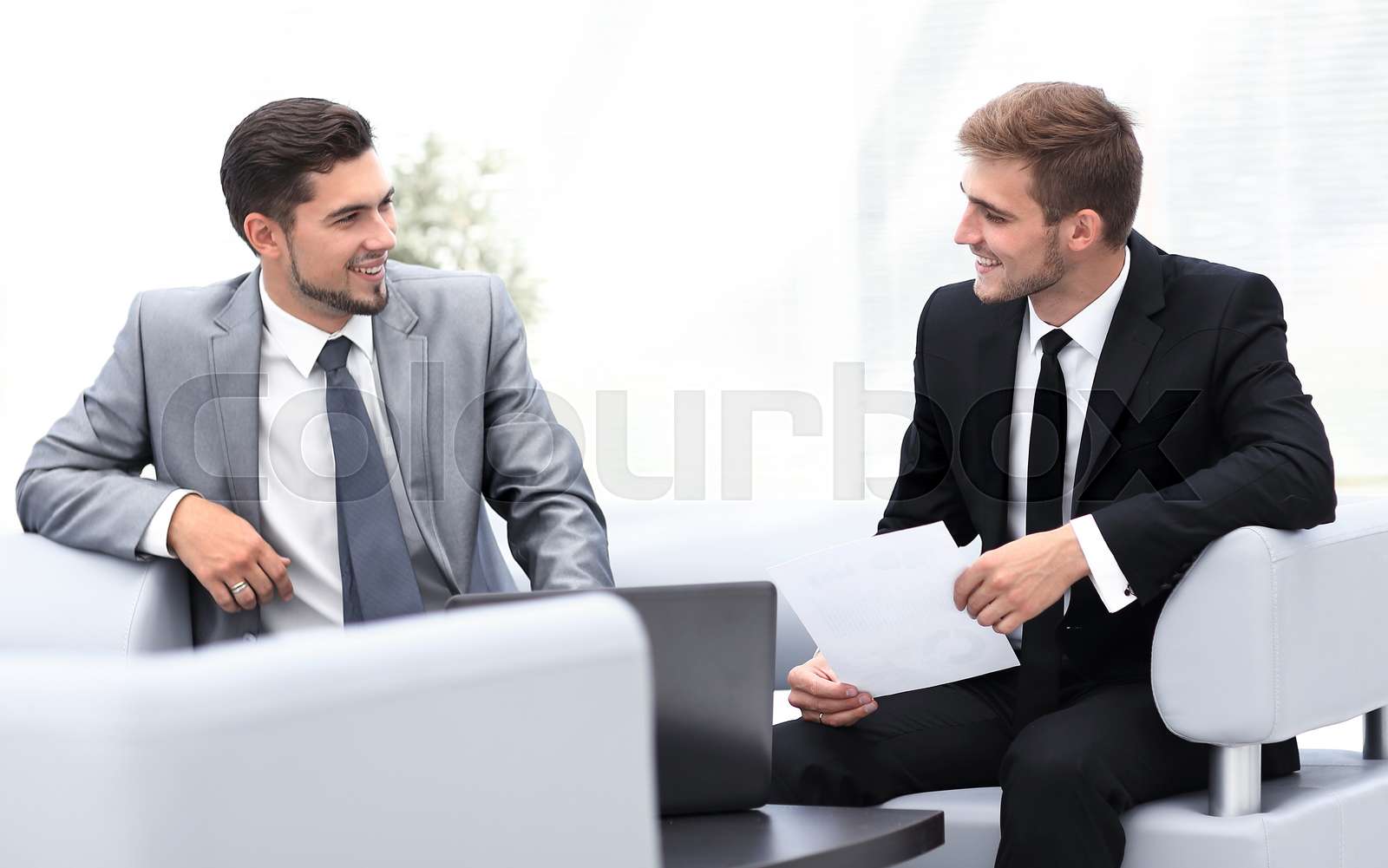 employees talking, sitting the lobby of the office | Stock image ...