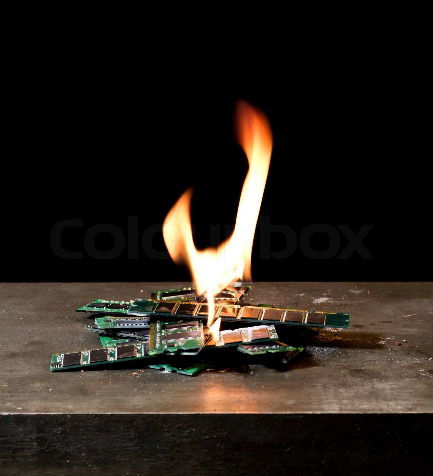 small pile of burning RAM sticks in front of dark back | Stock image ...