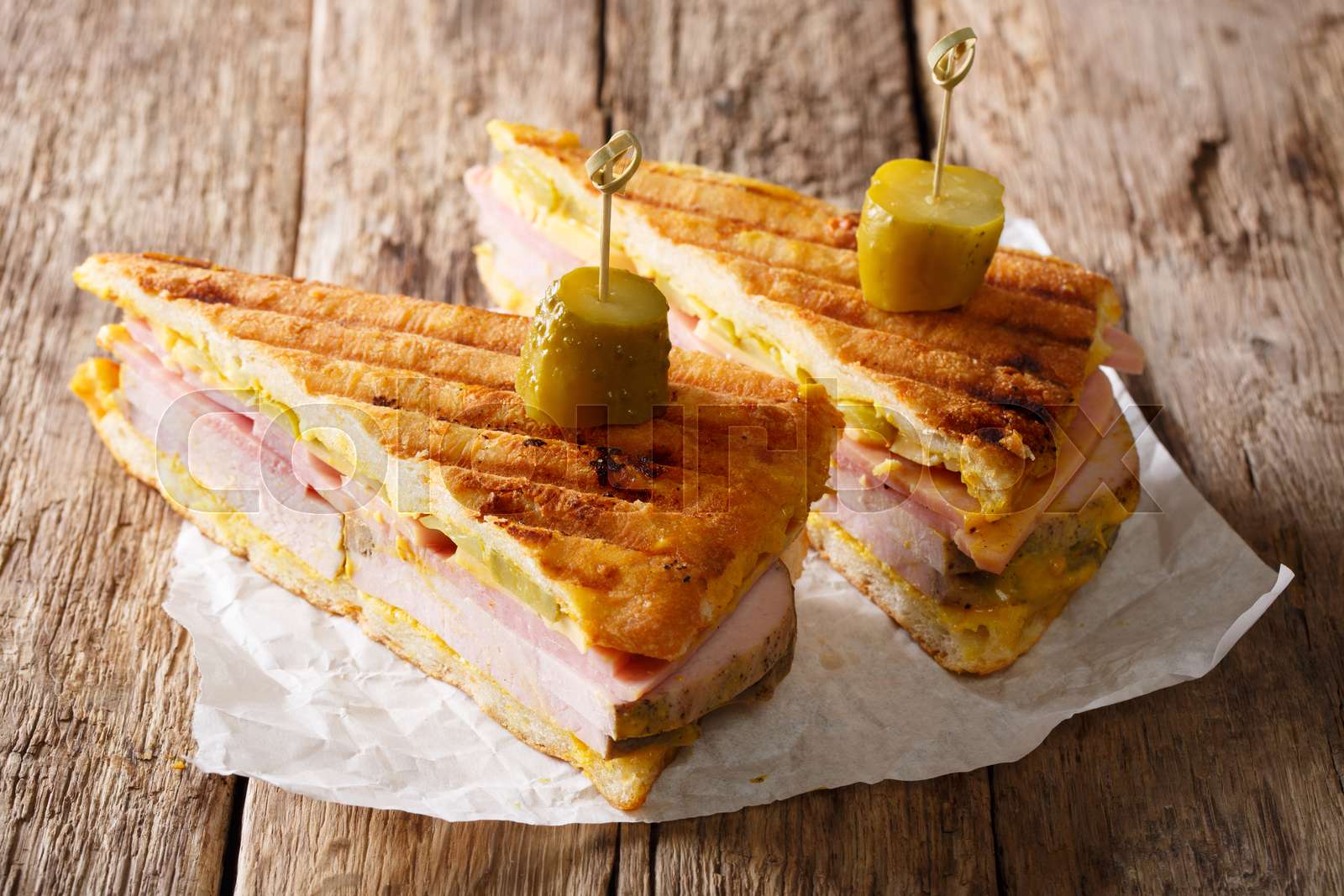 Cuban sandwich with ham, mustard, cheese, pickled and pork close-up ...