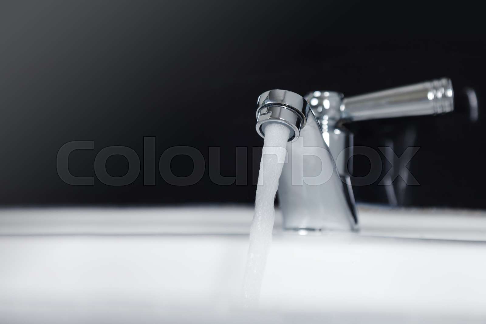Faucet and water flow on bathroom | Stock image | Colourbox