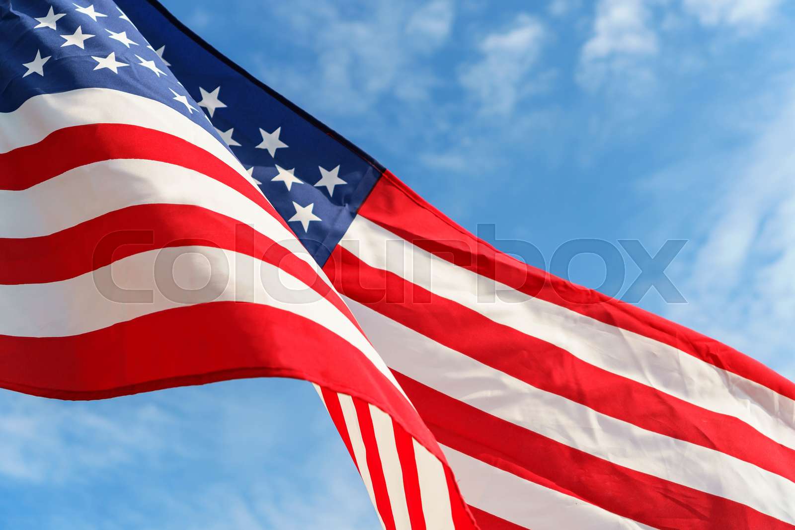 Waving star and stripes American flag on the blue sky | Stock image ...