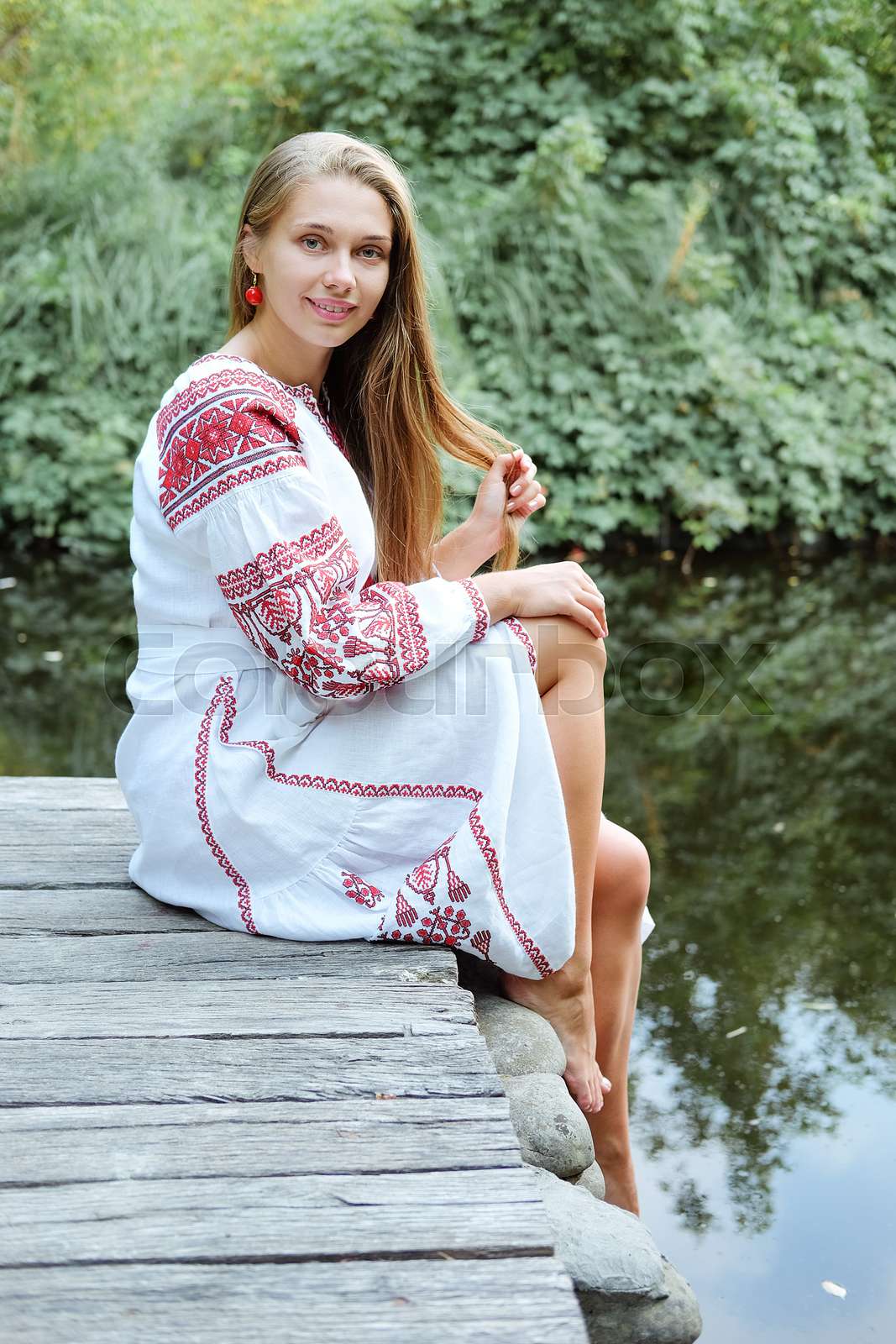 Beautiful Slavonic Girl With Long Blond Hair And Blue Eyes Sitting Near