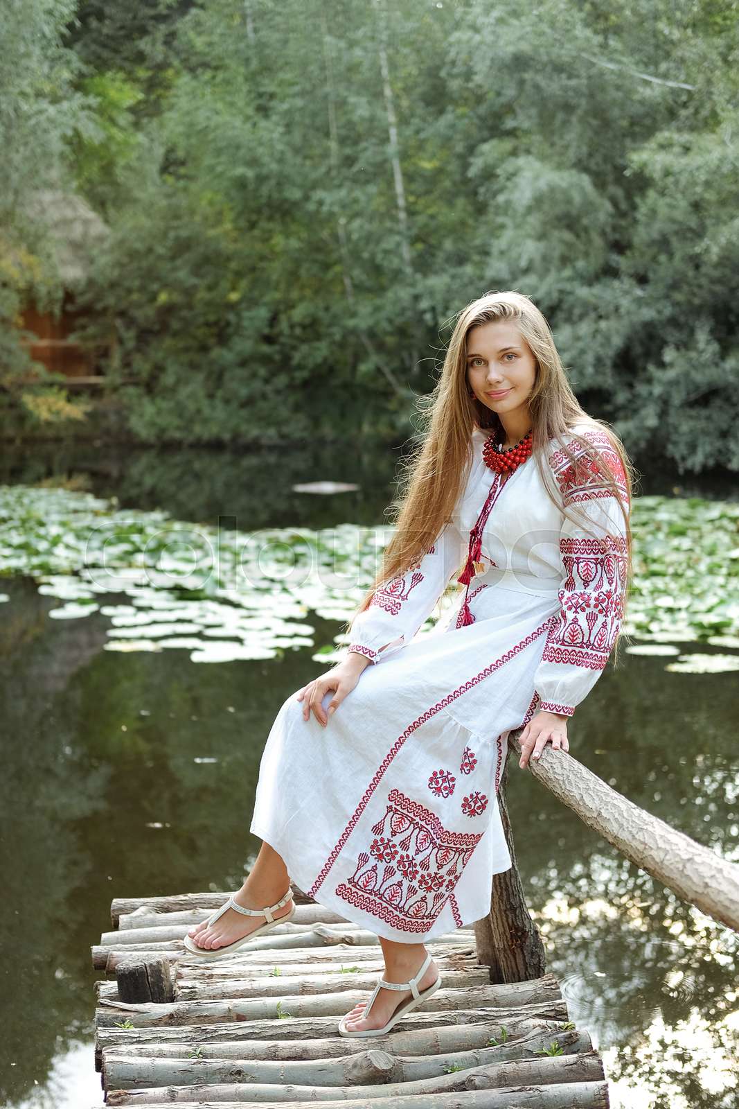Beautiful Slavonic Girl With Long Blond Hair And Blue Eyes Sitting Near