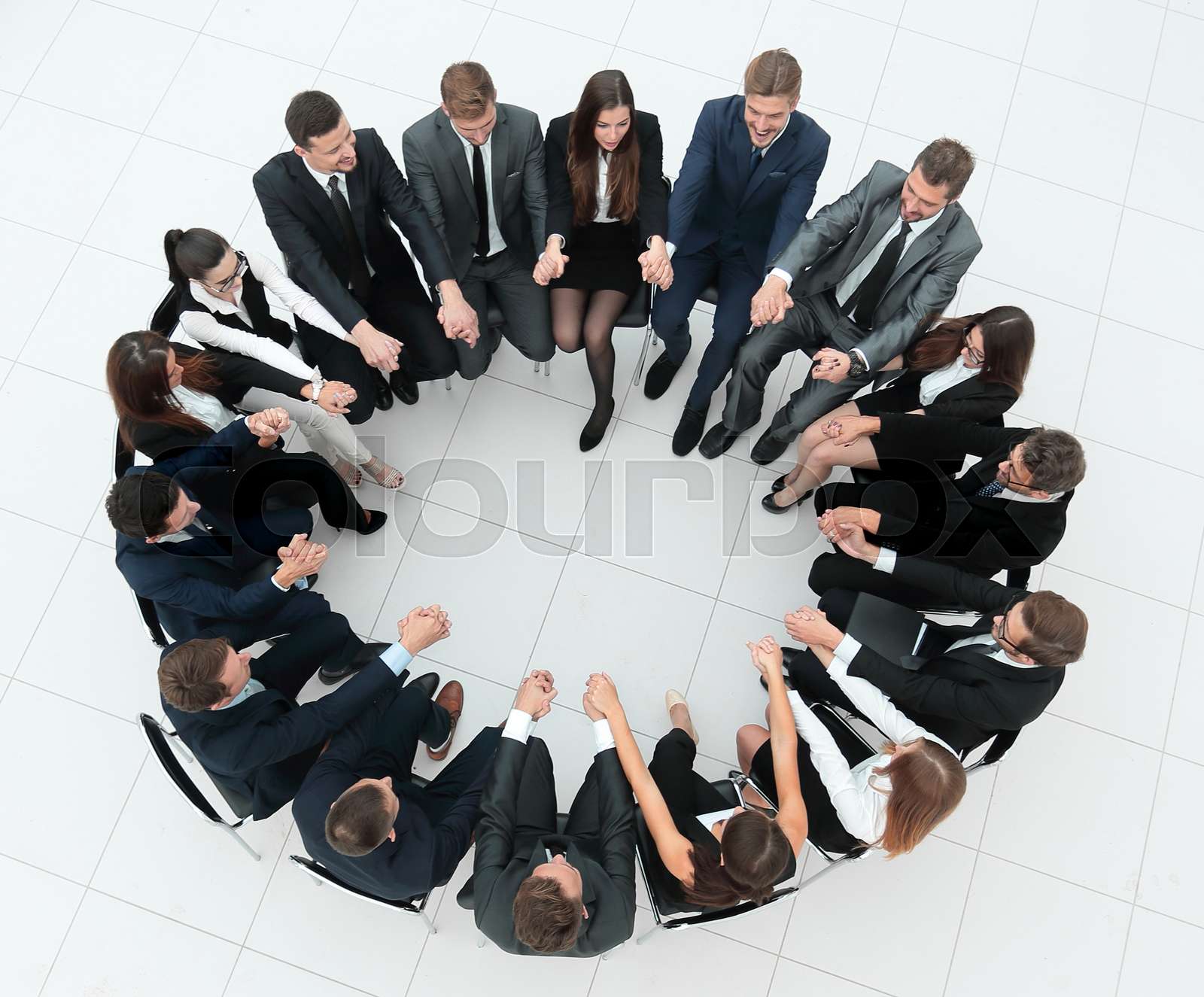 concept of team building.large business team sitting in a circle ...