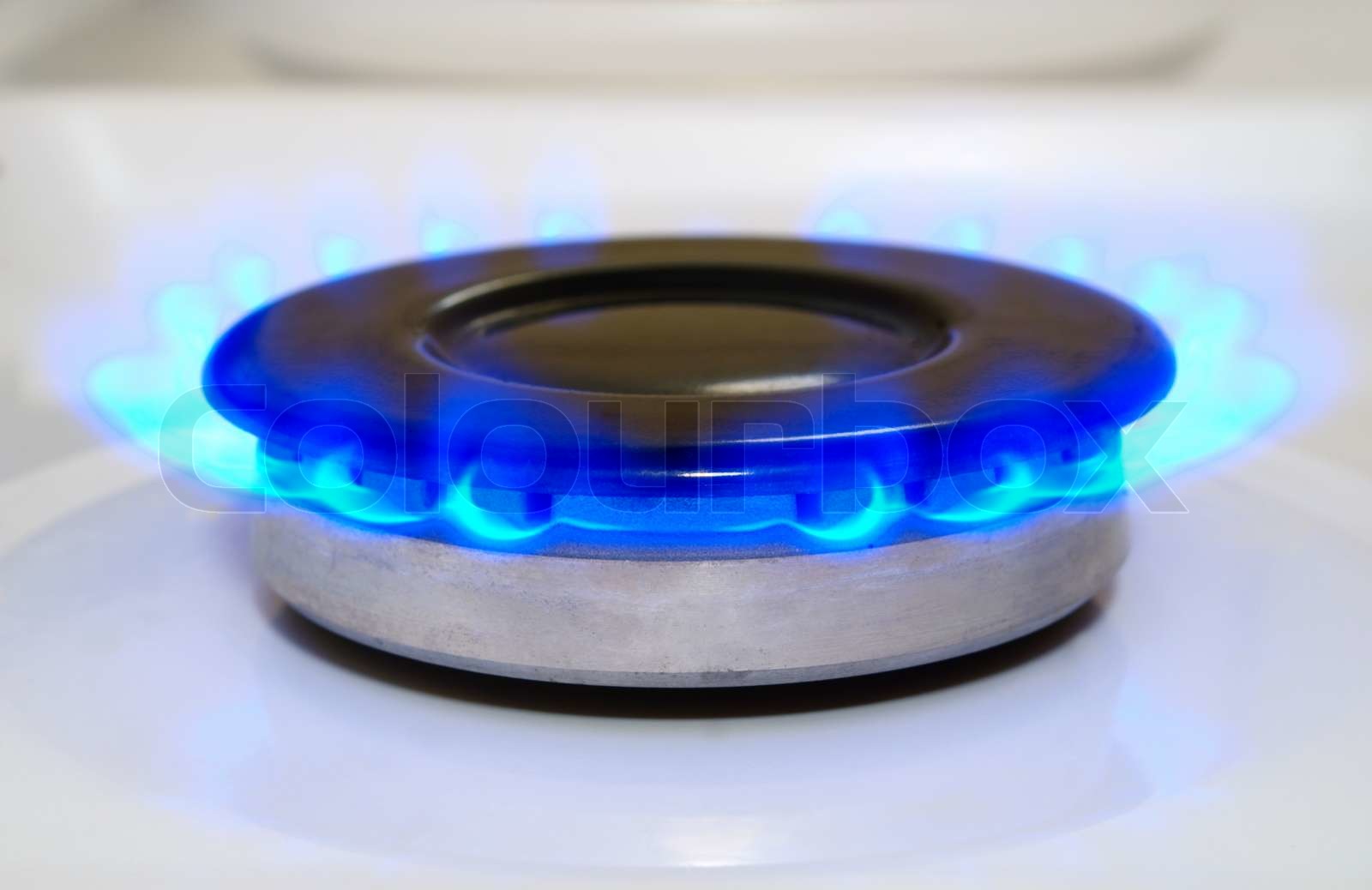 gas burner with a flame burning home plate | Stock image | Colourbox