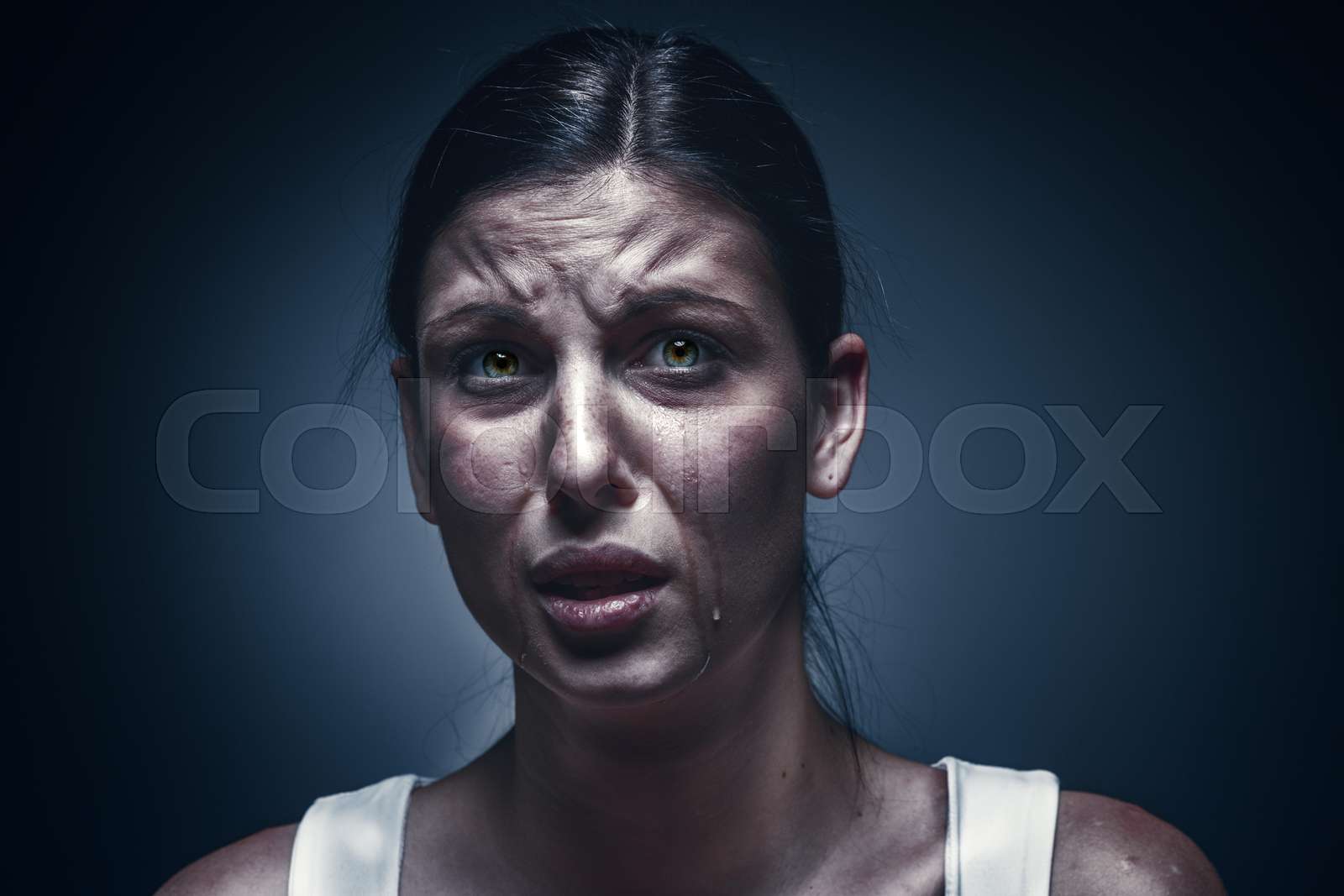 Close up portrait of a crying woman with bruised skin and black eyes ...