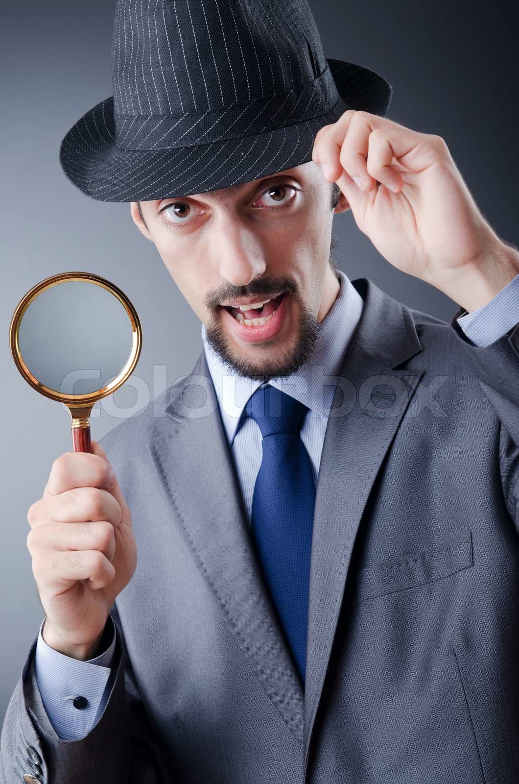 Detective and magnifying glass | Stock image | Colourbox