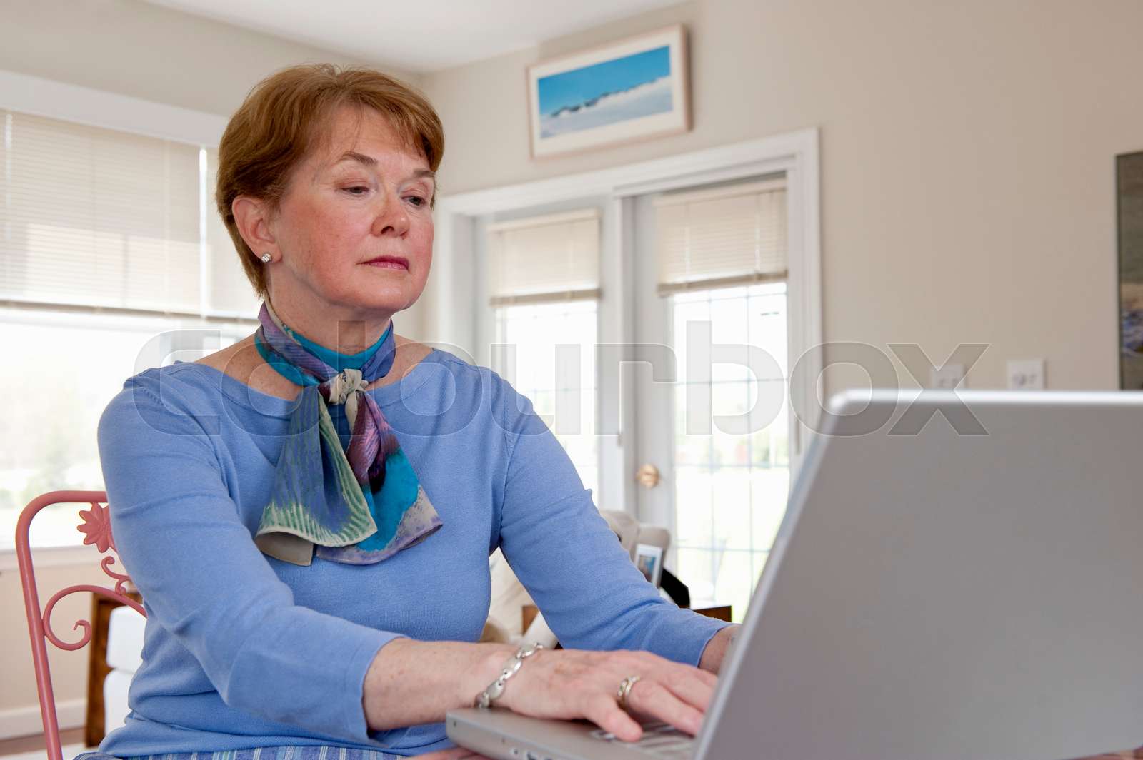 Mature woman working on computer | Stock image | Colourbox