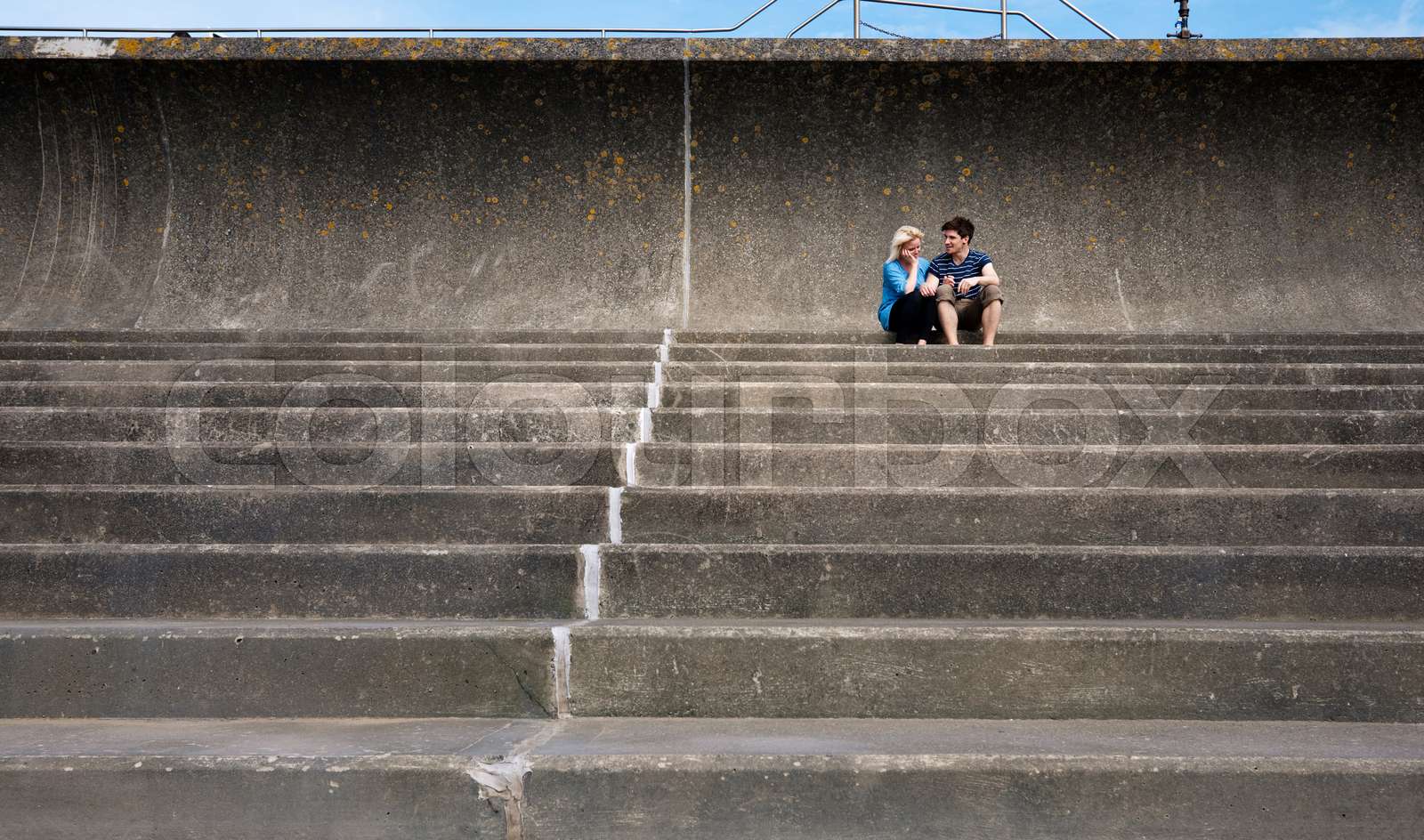 Couple sitting together on steps | Stock image | Colourbox
