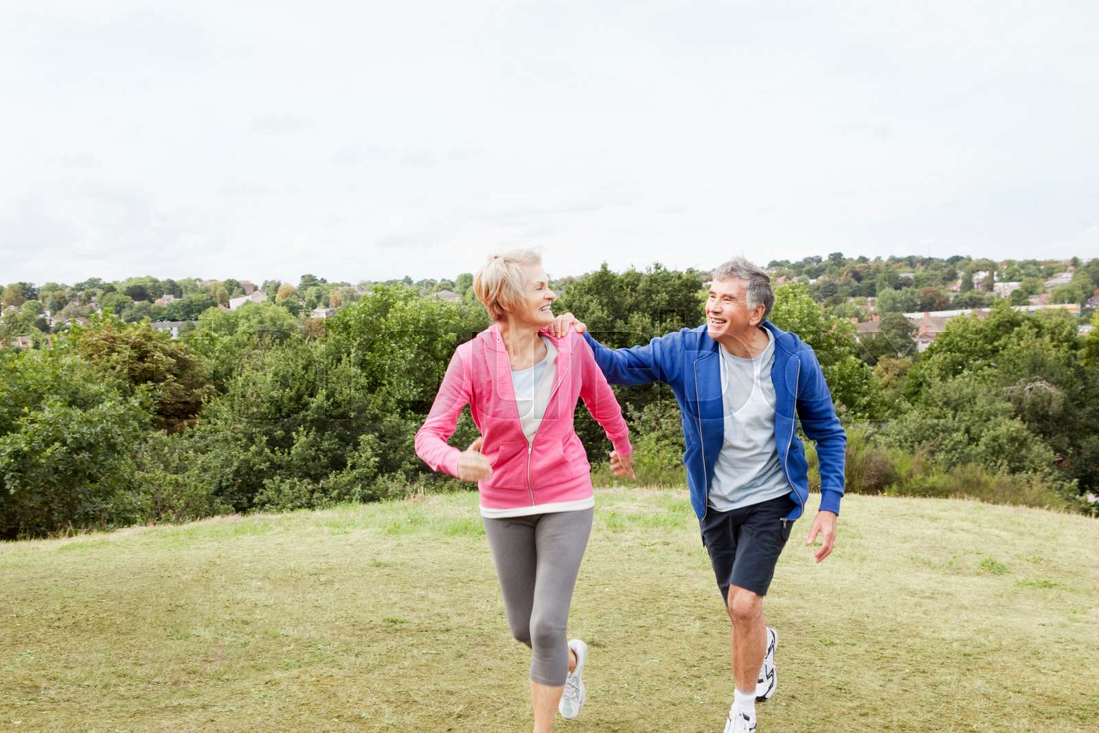 Mature man holding onto jogging partner | Stock image | Colourbox