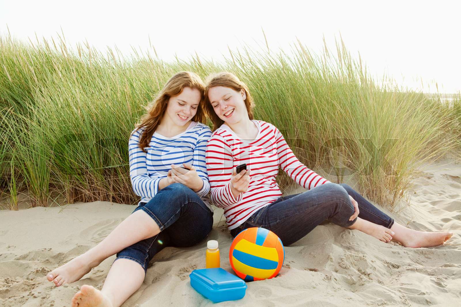 Teenagers texting and comparing messages | Stock image | Colourbox