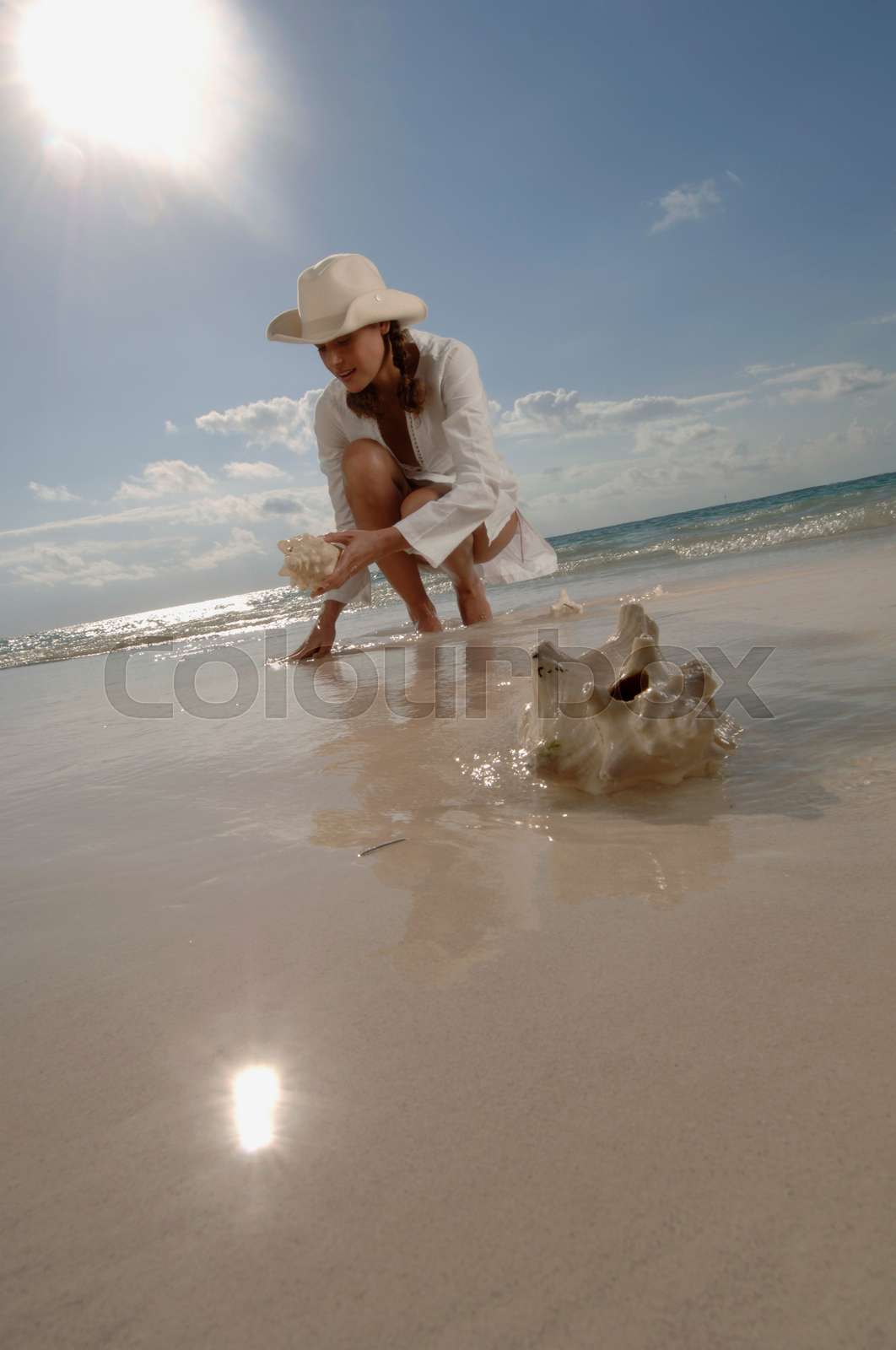 Woman collecting clams | Stock image | Colourbox