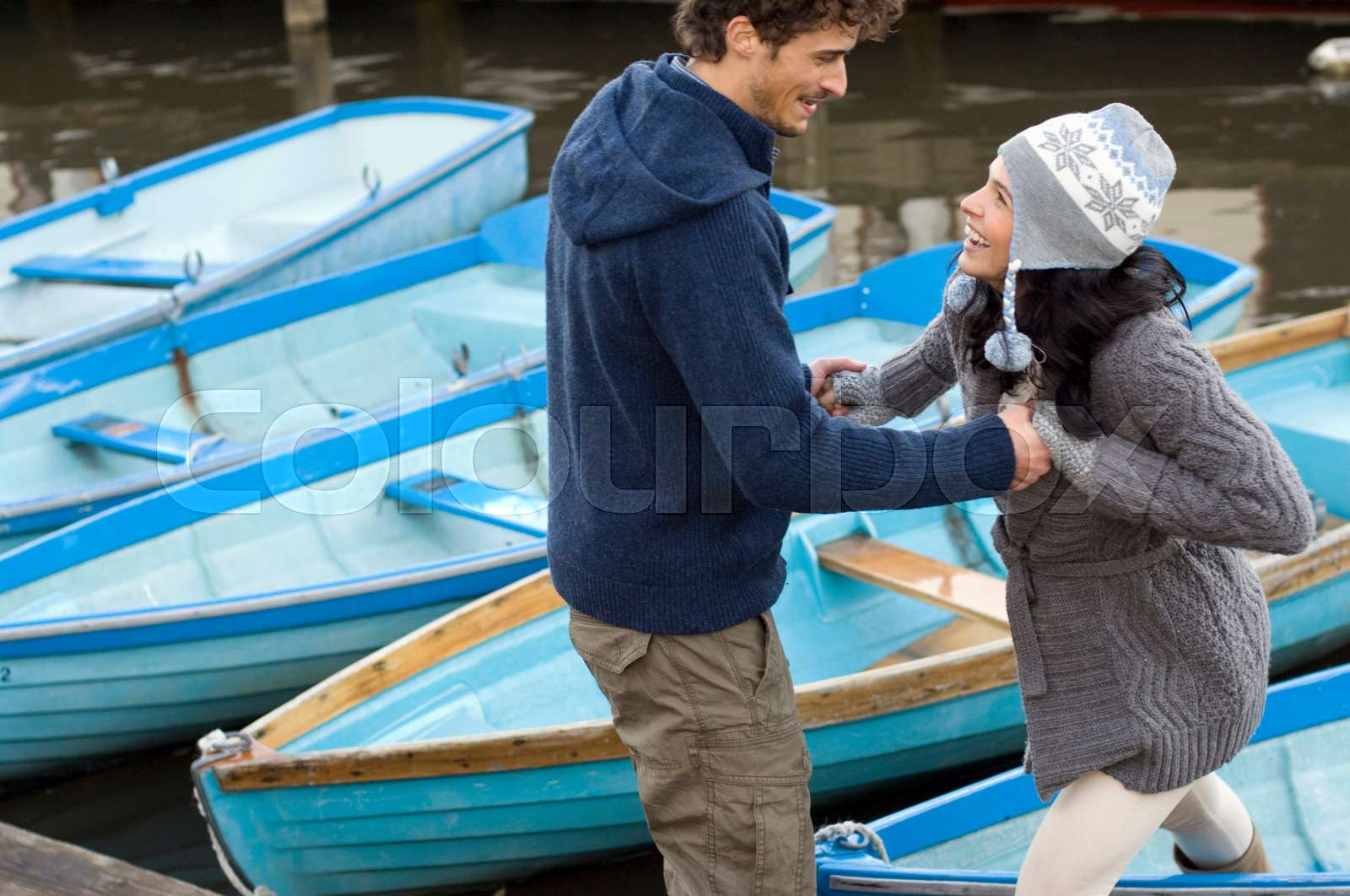 Man helping woman off boat | Stock image | Colourbox