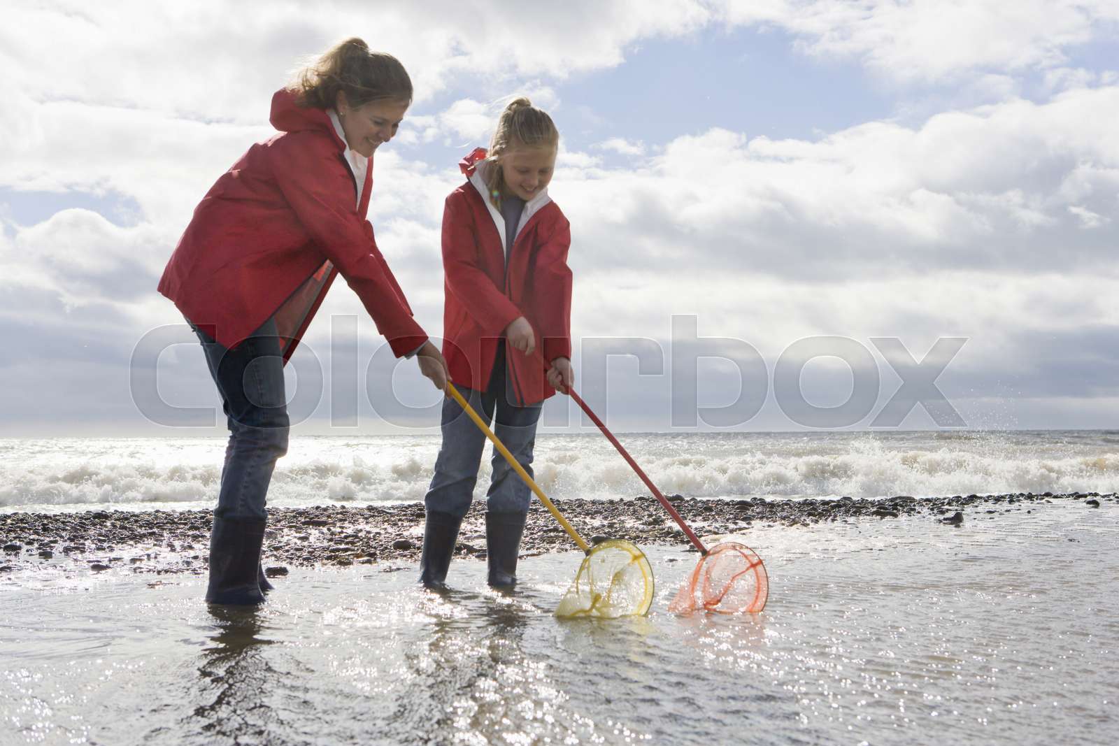 Mother and daughter fishing with fishnet | Stock image | Colourbox