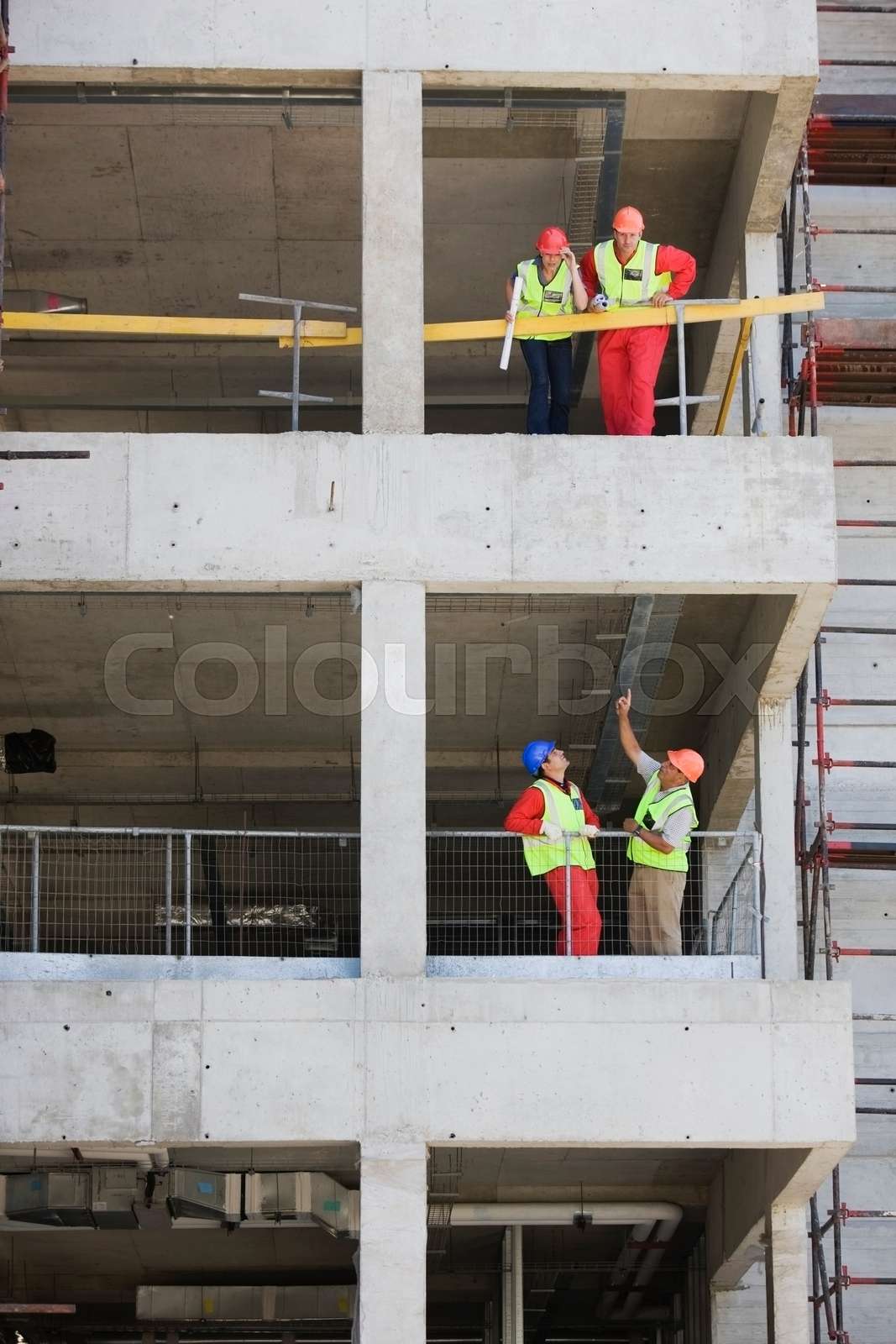 Building workers in a shell of building - Stock Image - Everypixel
