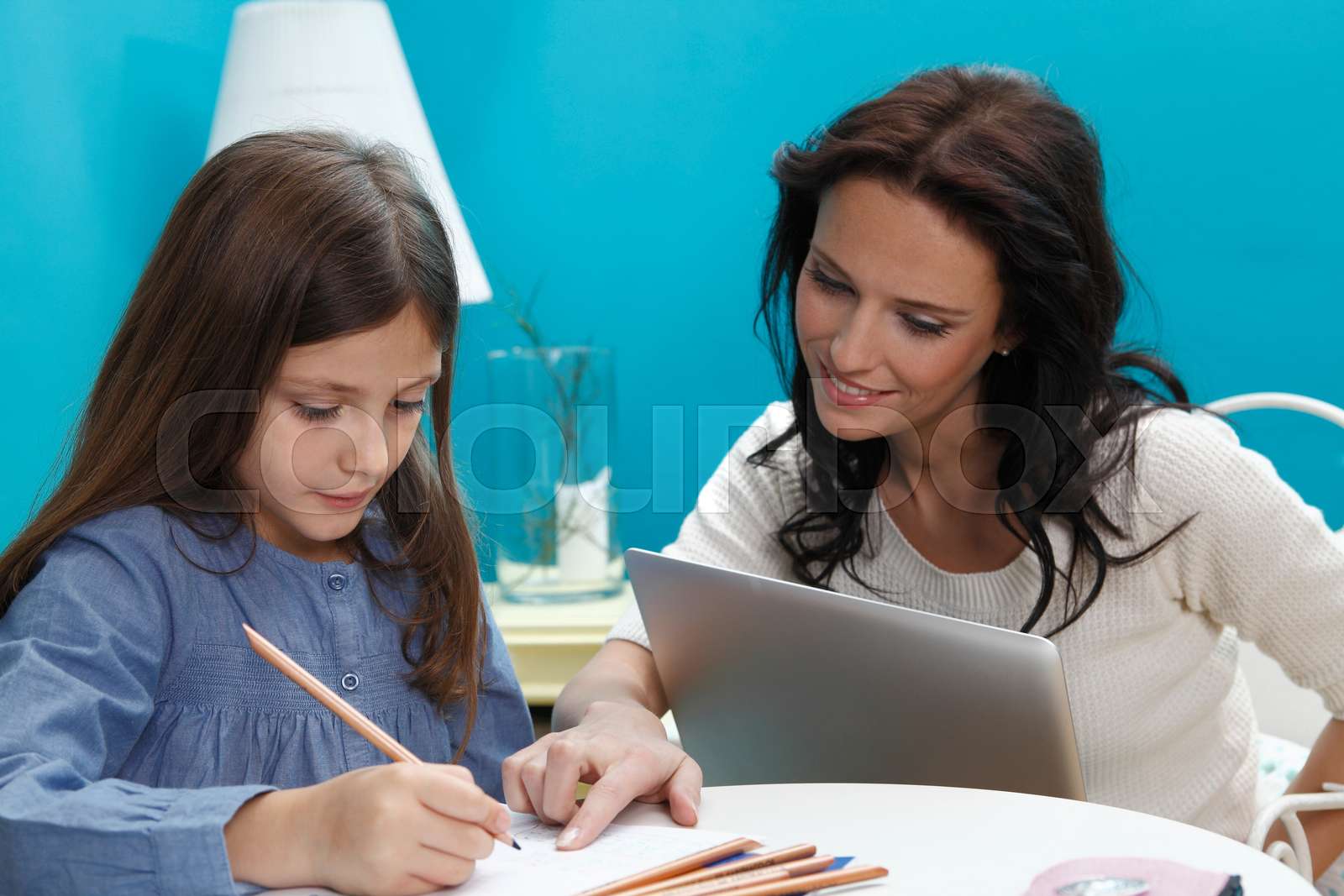 woman helping girl work | Stock image | Colourbox