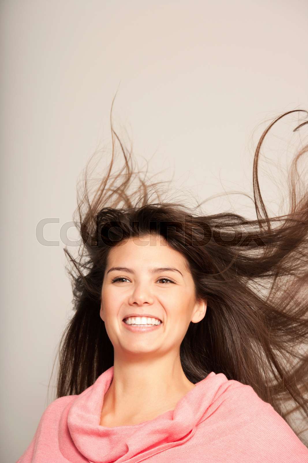 Headshot of a young woman hair flying | Stock image | Colourbox