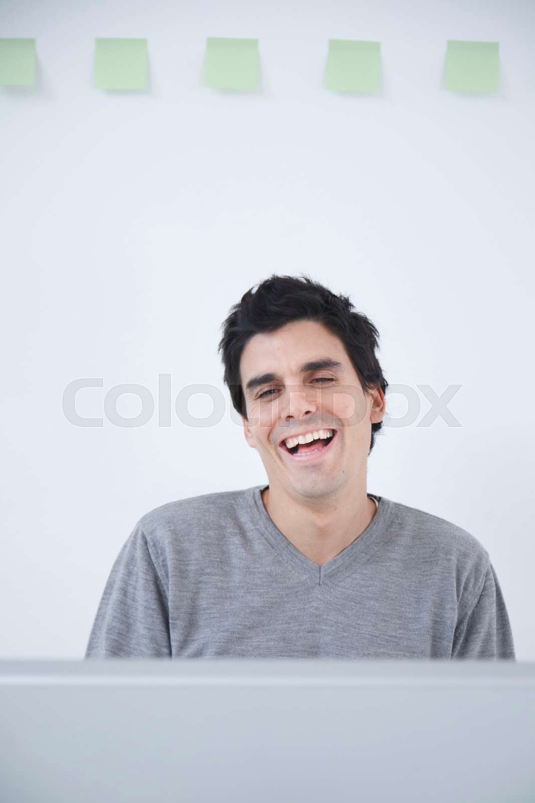 Man laughing at computer | Stock image | Colourbox