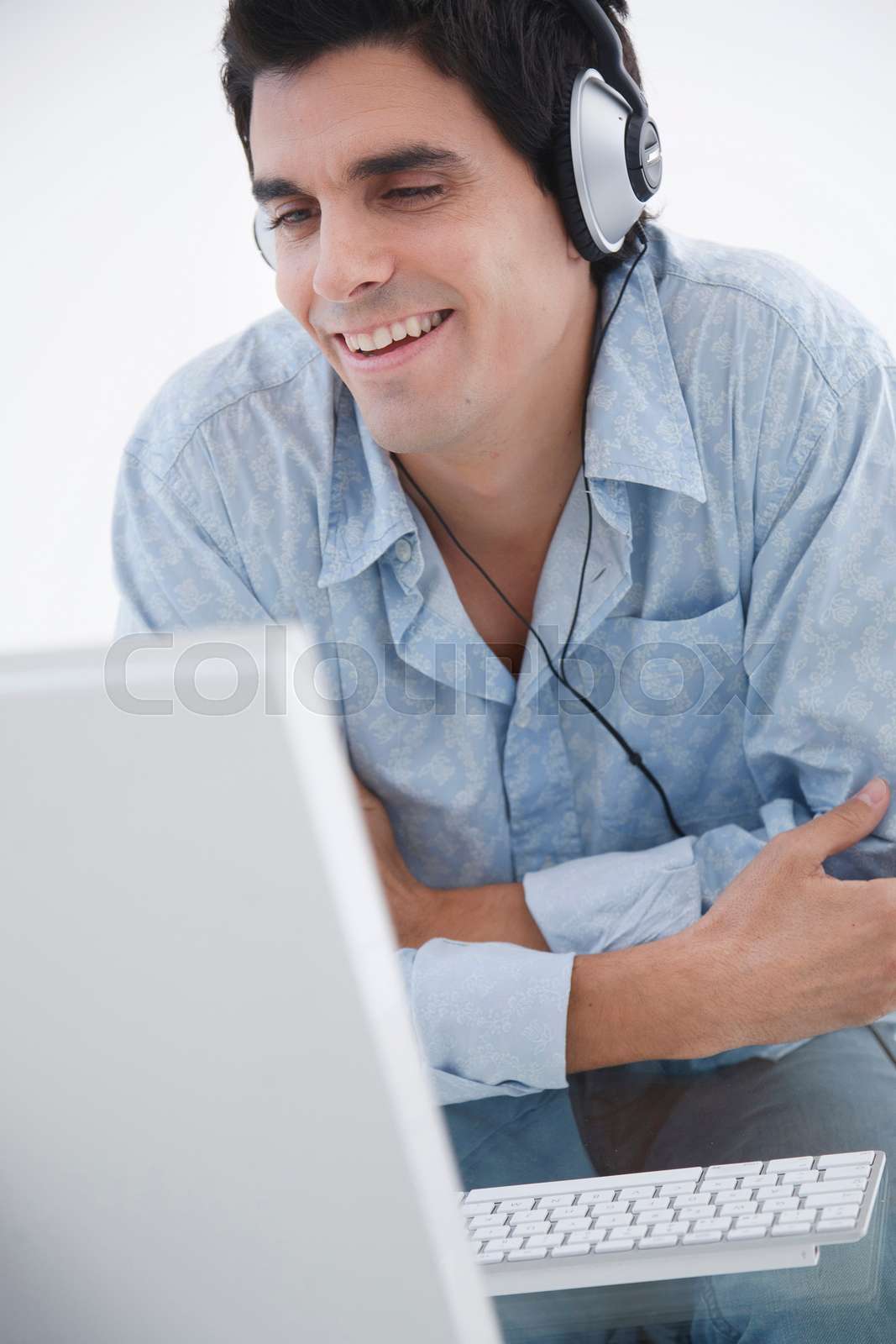 Man laughing at computer | Stock image | Colourbox