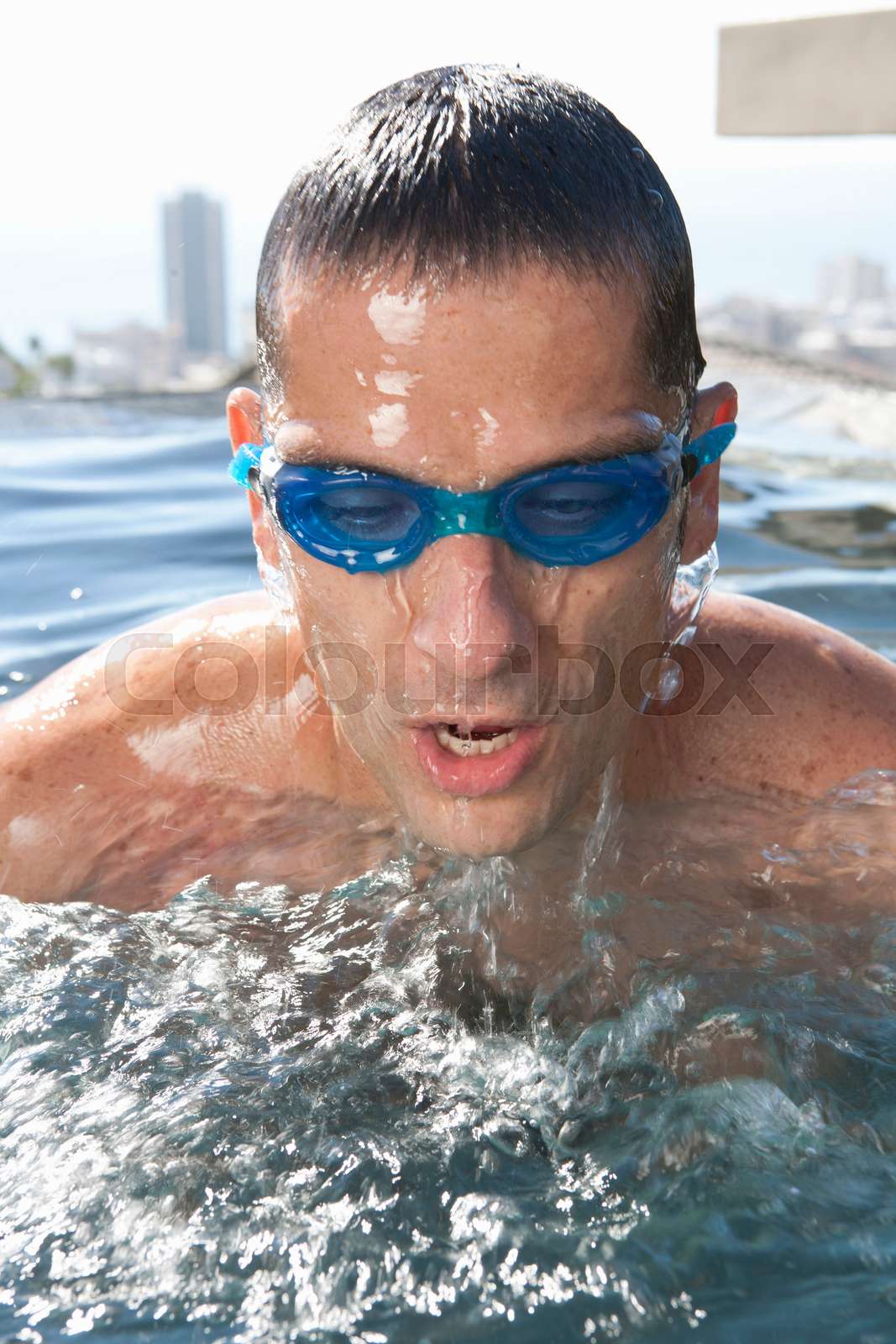 Man wearing goggles in swimming pool | Stock image | Colourbox