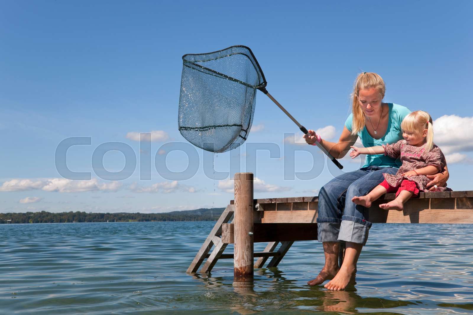 Mother and daughter fishing with net | Stock image | Colourbox