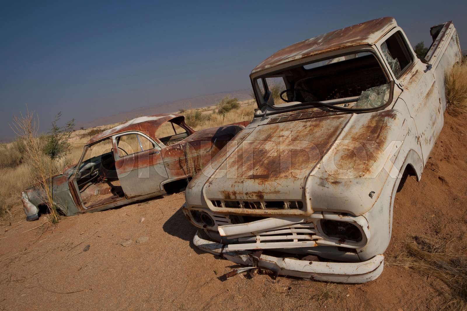 Rusting cars submerged in sand | Stock image | Colourbox