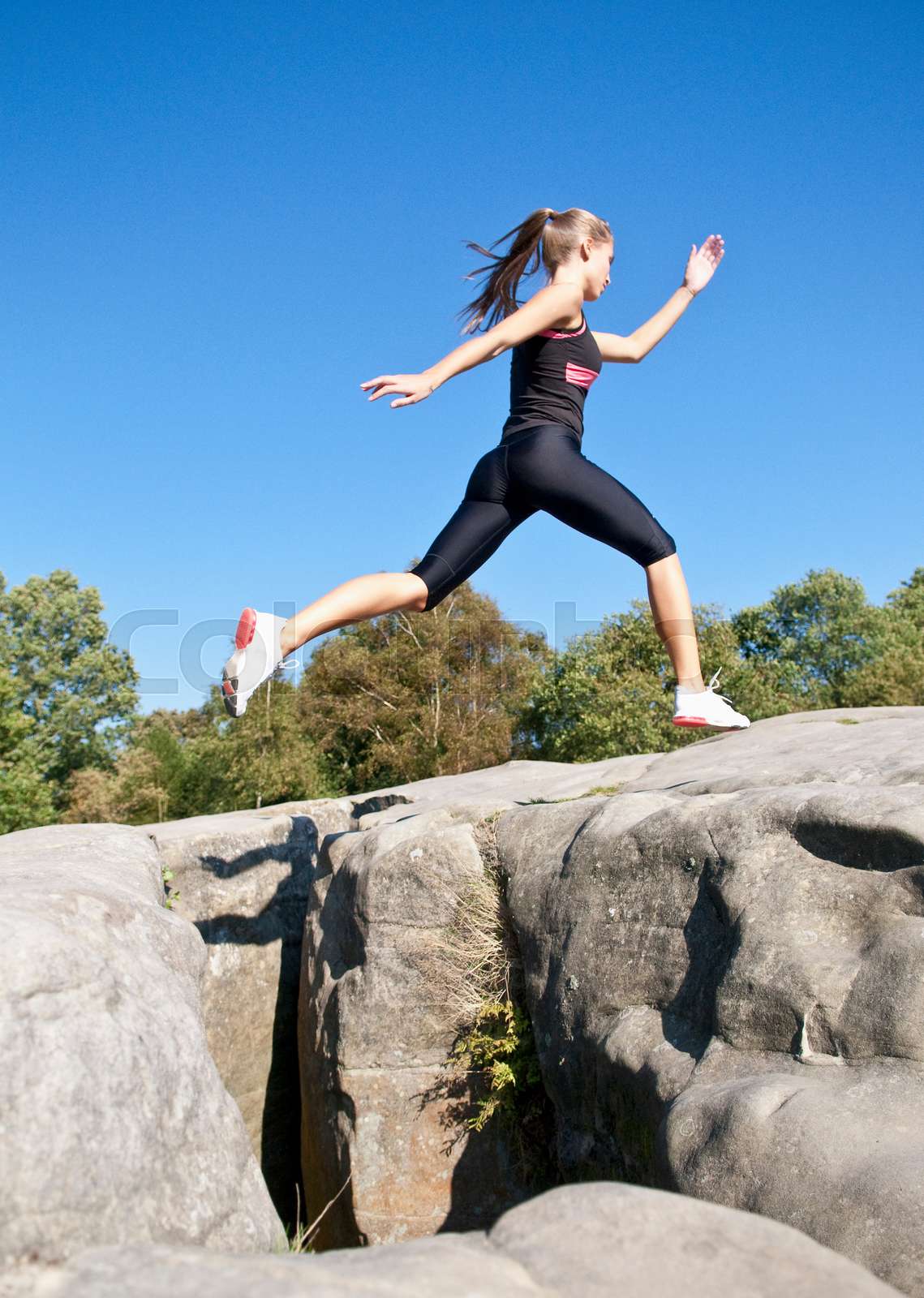 Rock climber jumping between rocks | Stock image | Colourbox