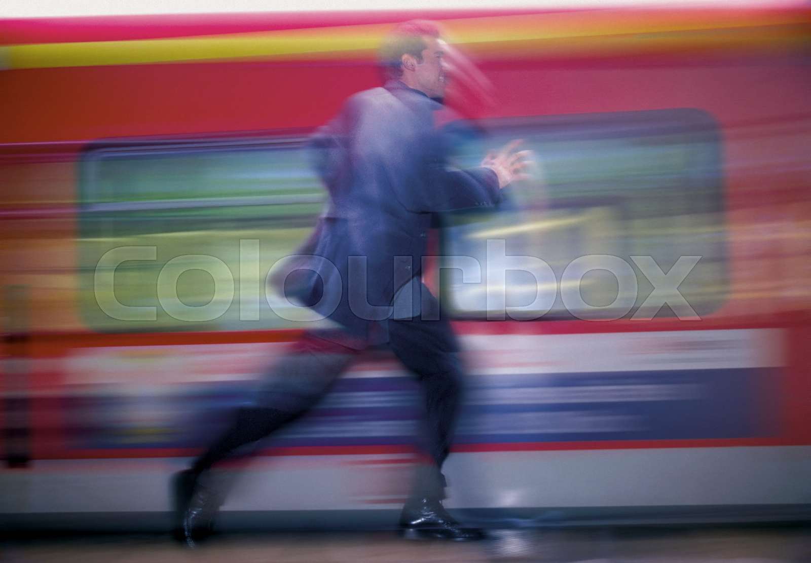 Man running after train | Stock image | Colourbox