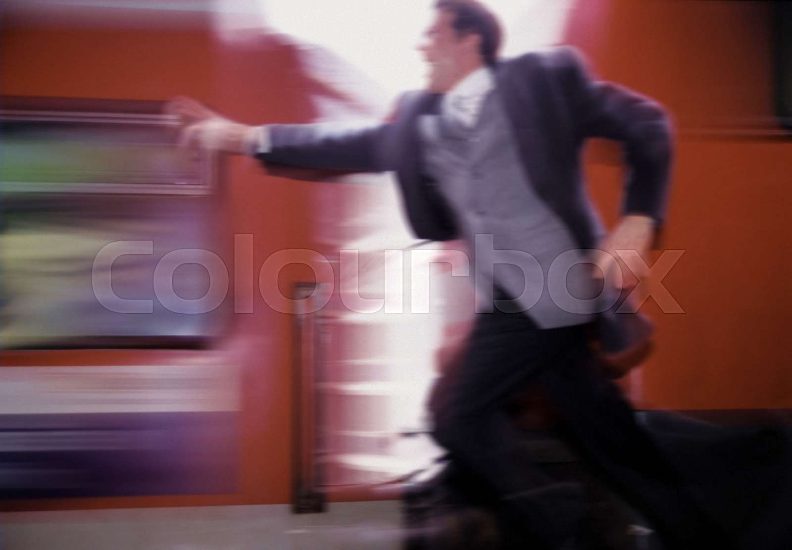 Man running after train | Stock image | Colourbox