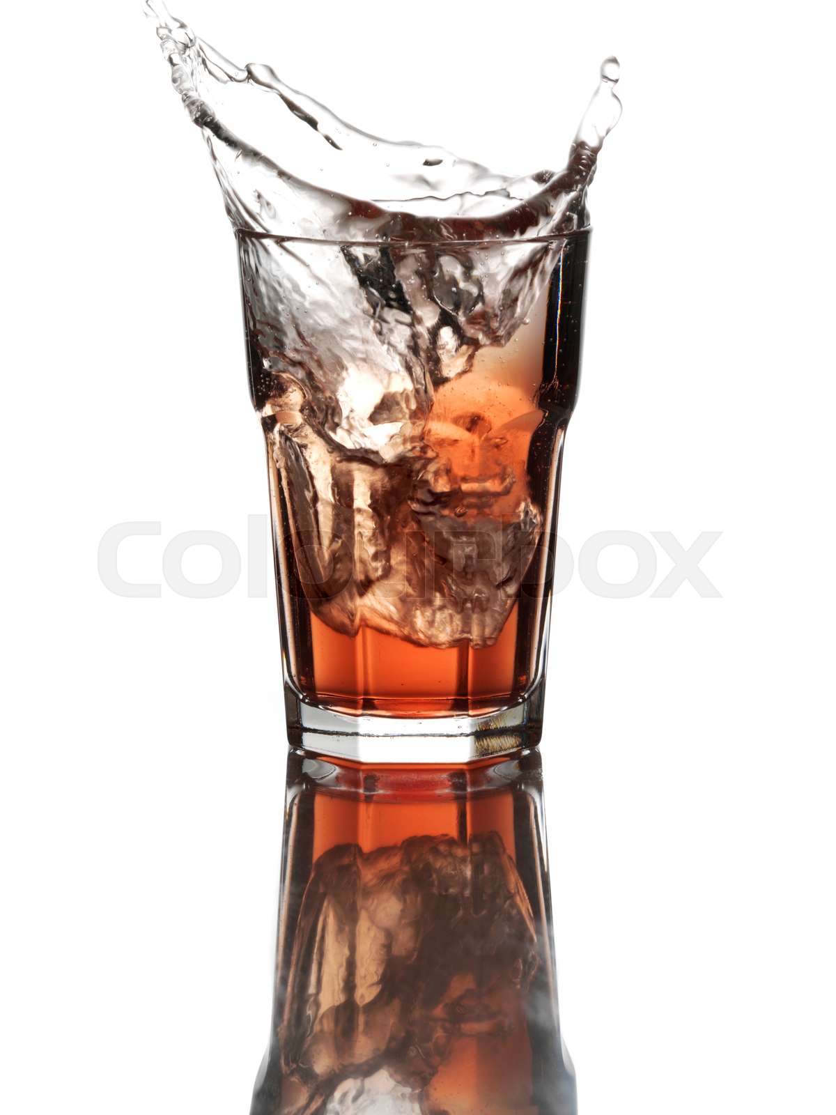 Ice cube dropping into drink | Stock image | Colourbox