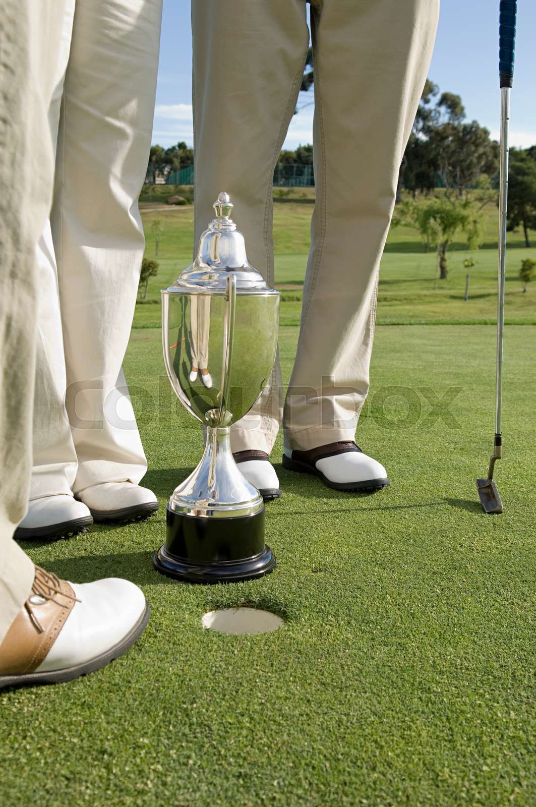 Golfers legs and a trophy | Stock image | Colourbox
