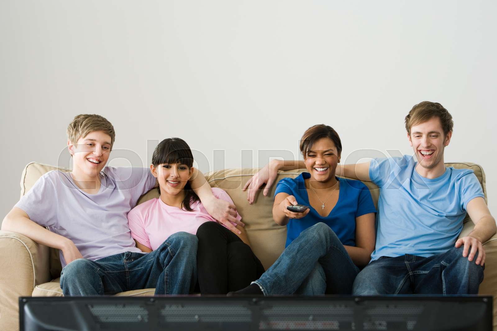 Friends watching tv | Stock image | Colourbox