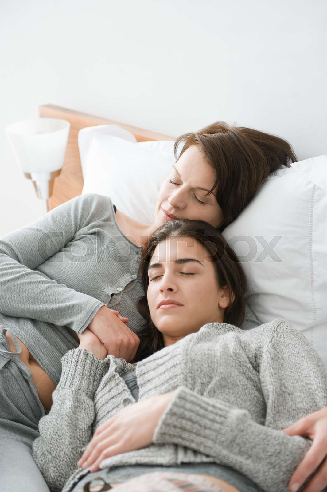 Two women sleeping on bed | Stock image | Colourbox