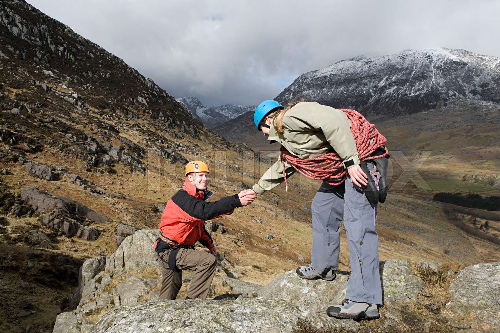 A woman giving a man a helping hand | Stock image | Colourbox