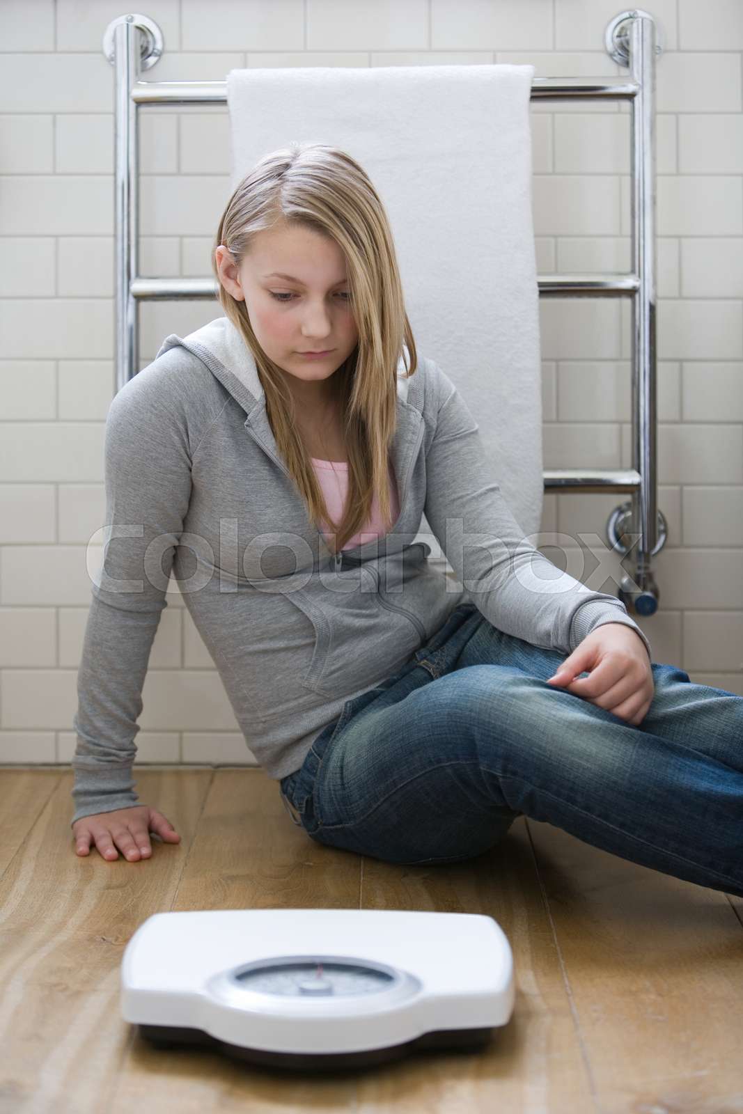 A girl looking at scales | Stock image | Colourbox