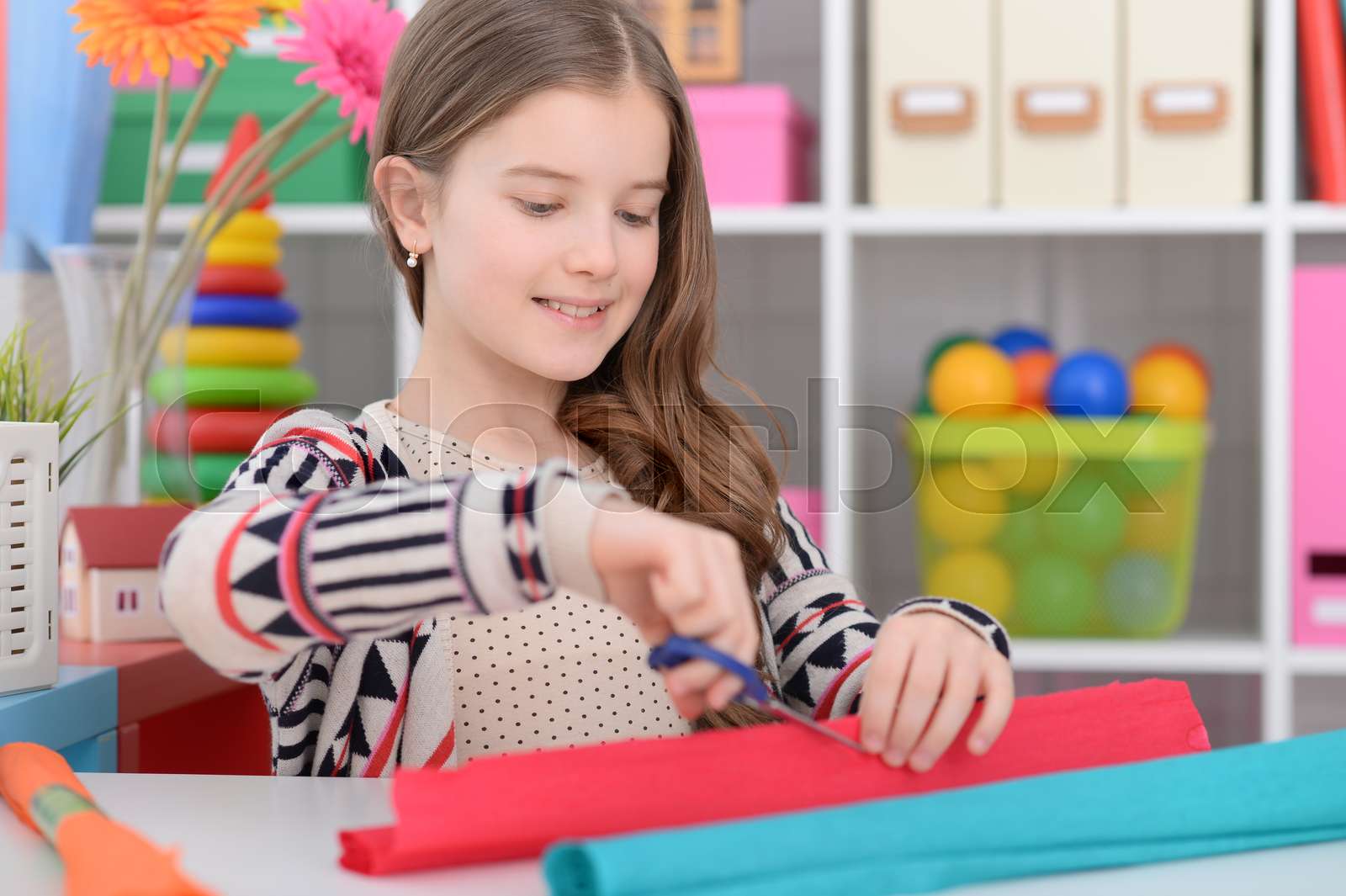 Girl snipping paper | Stock image | Colourbox