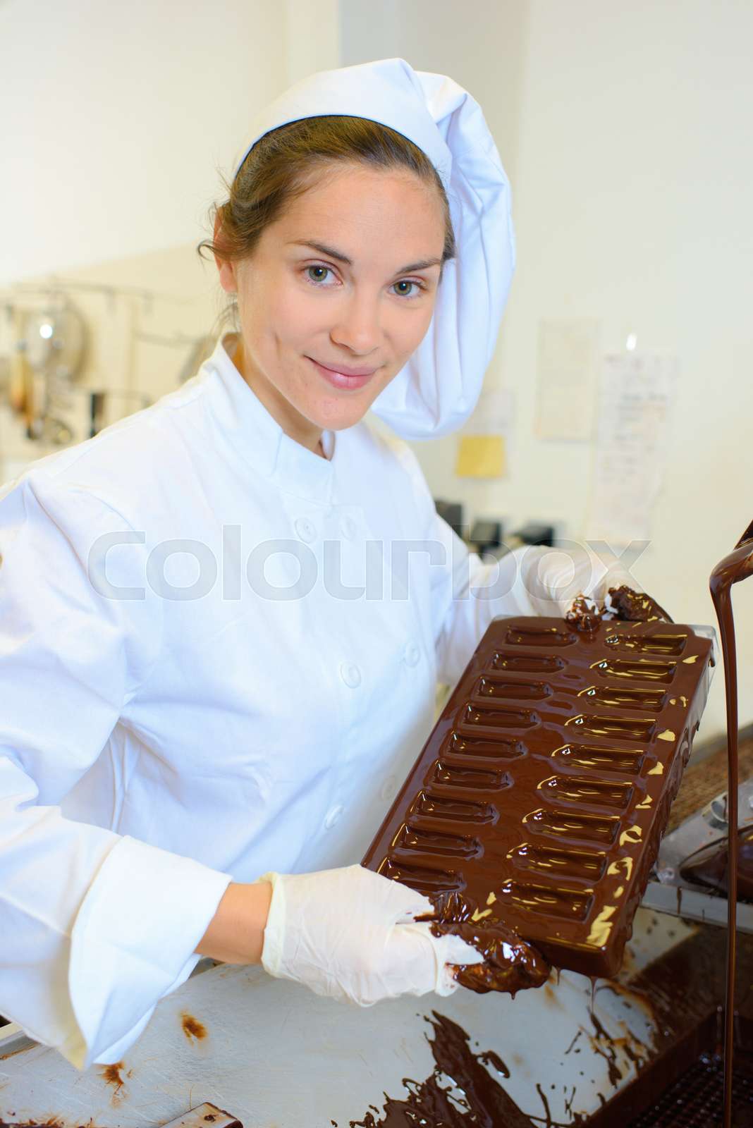 Lady showing chocolate creation | Stock image | Colourbox