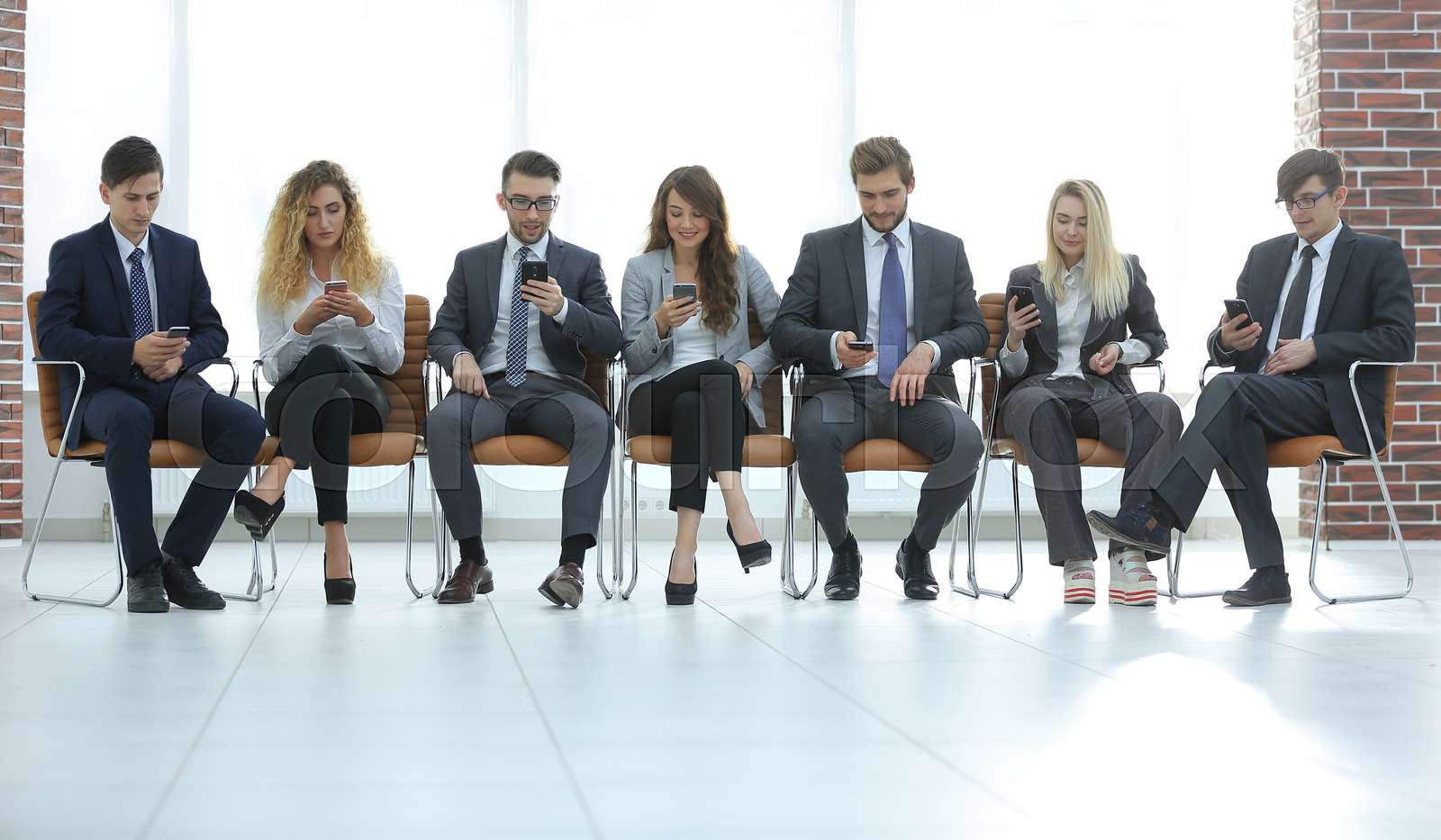 employees using smartphones in the office. | Stock image | Colourbox