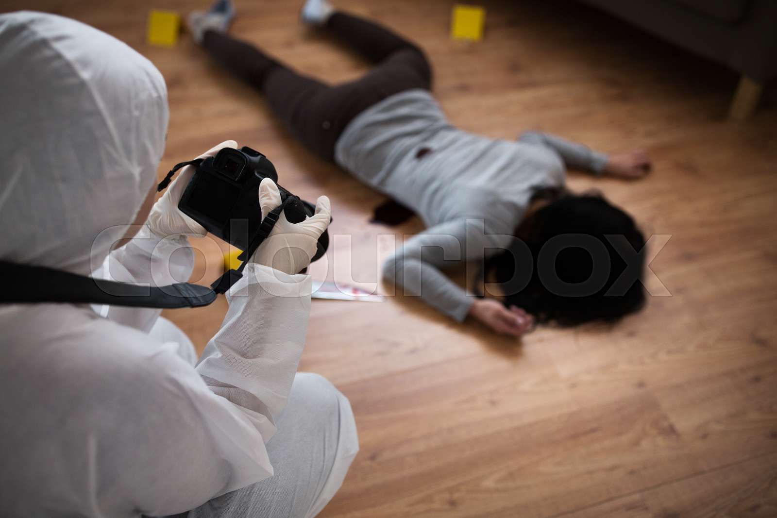 criminalist photographing dead body at crime scene | Stock image ...