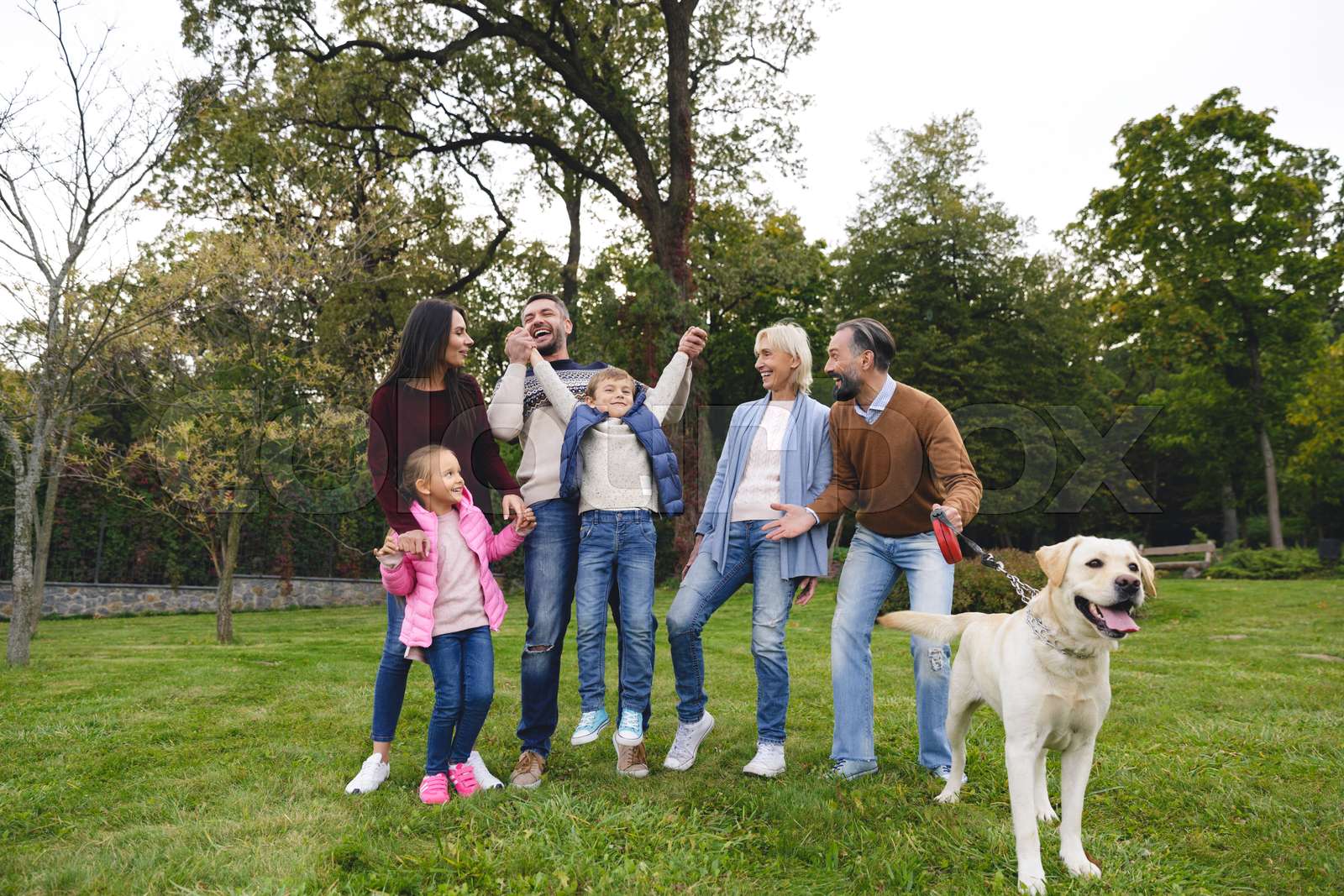 Excited big family with labrador retriever dog | Stock image | Colourbox
