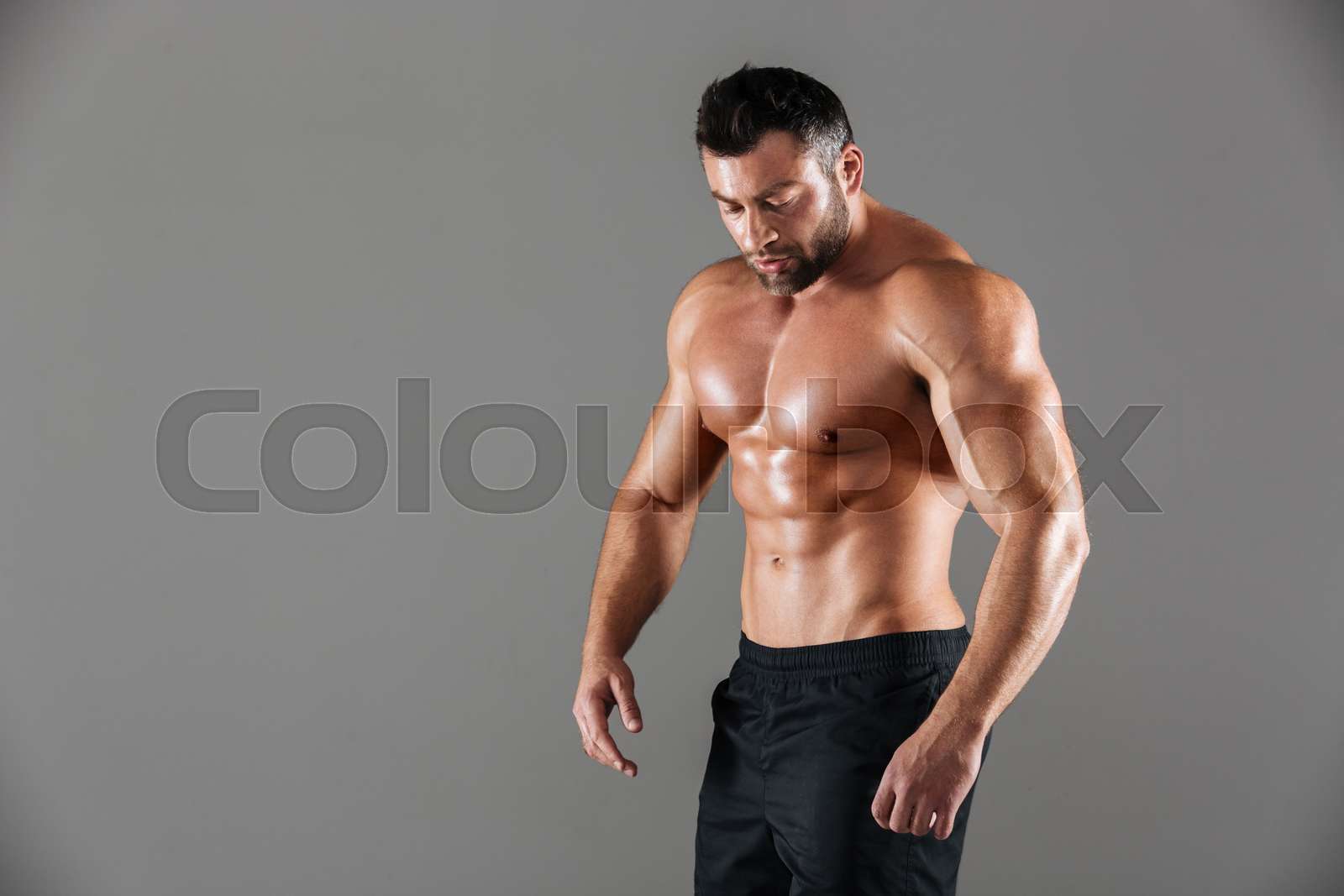 Portrait of a concentrated strong shirtless male bodybuilder | Stock ...