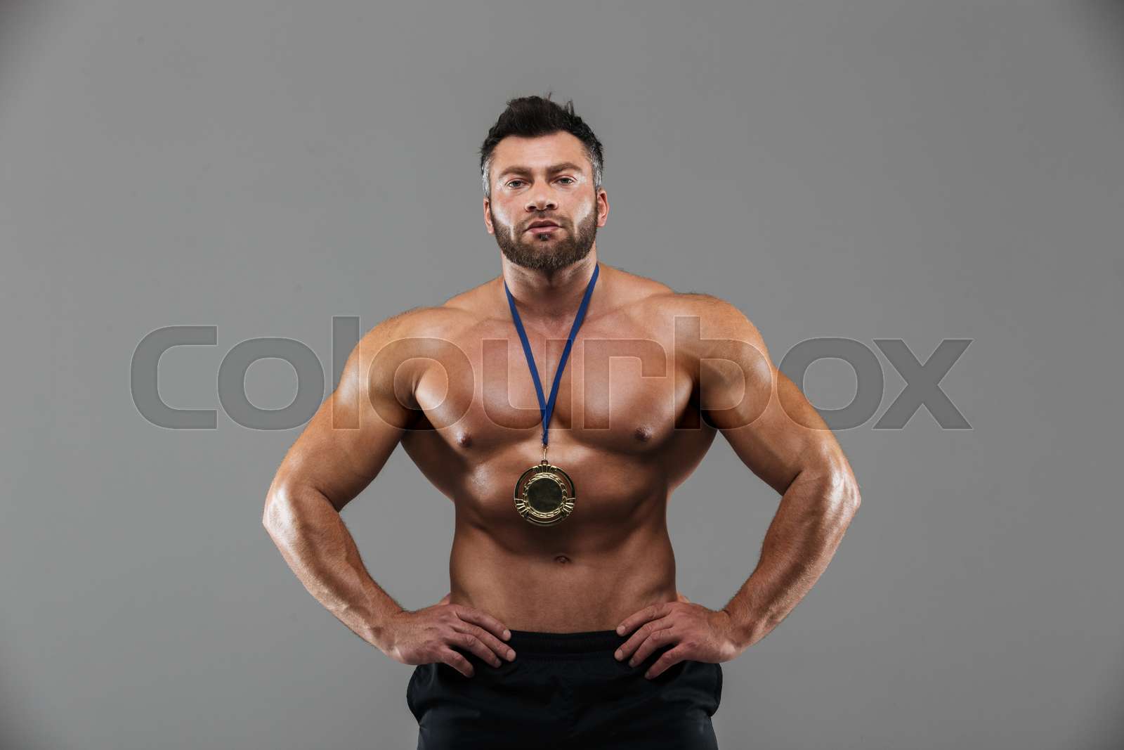Portrait of a fit satisfied shirtless male bodybuilder posing | Stock ...