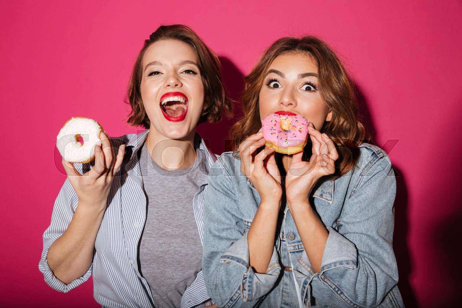 Ladies friends eating donuts | Stock image | Colourbox