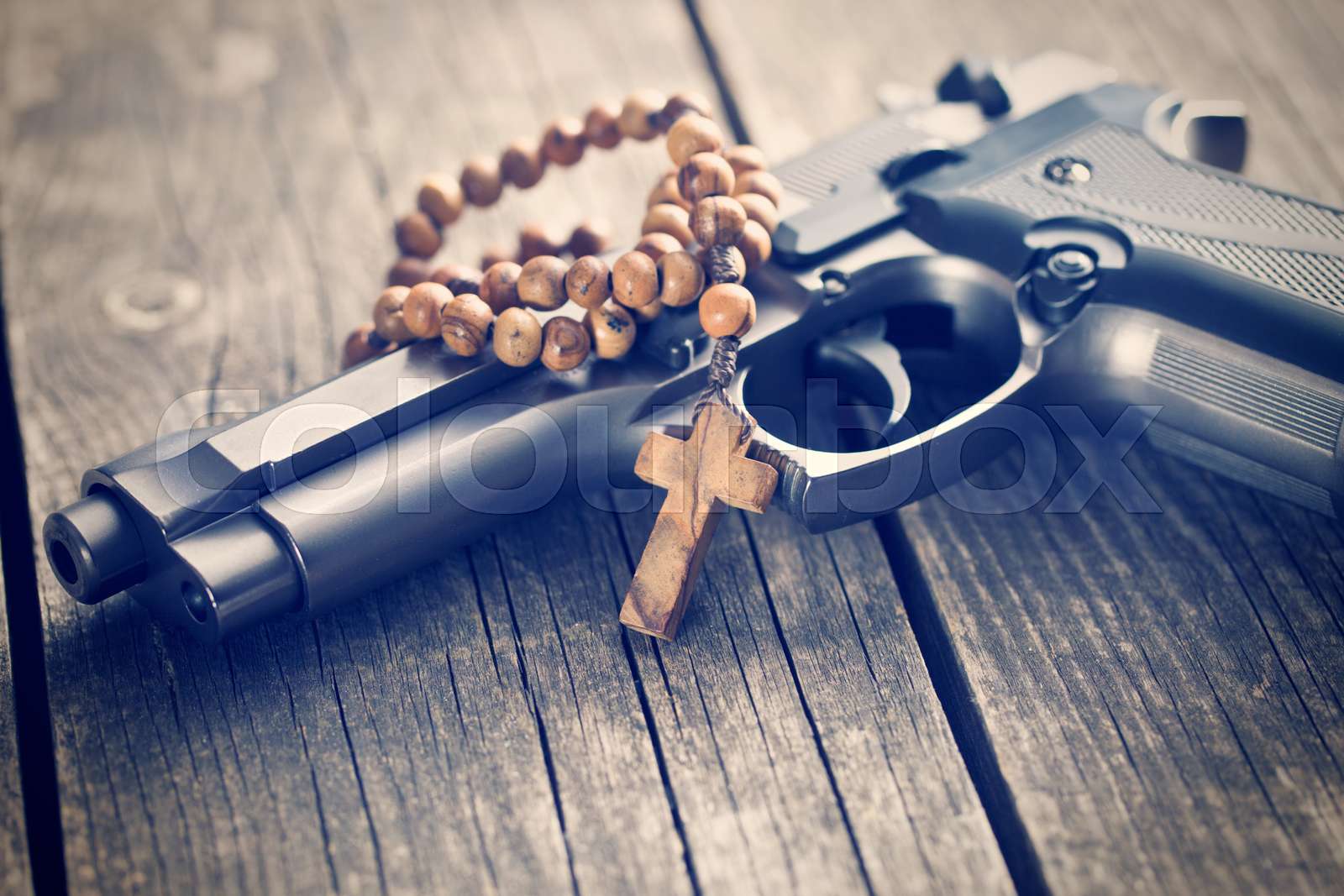 rosary beads and gun | Stock image | Colourbox